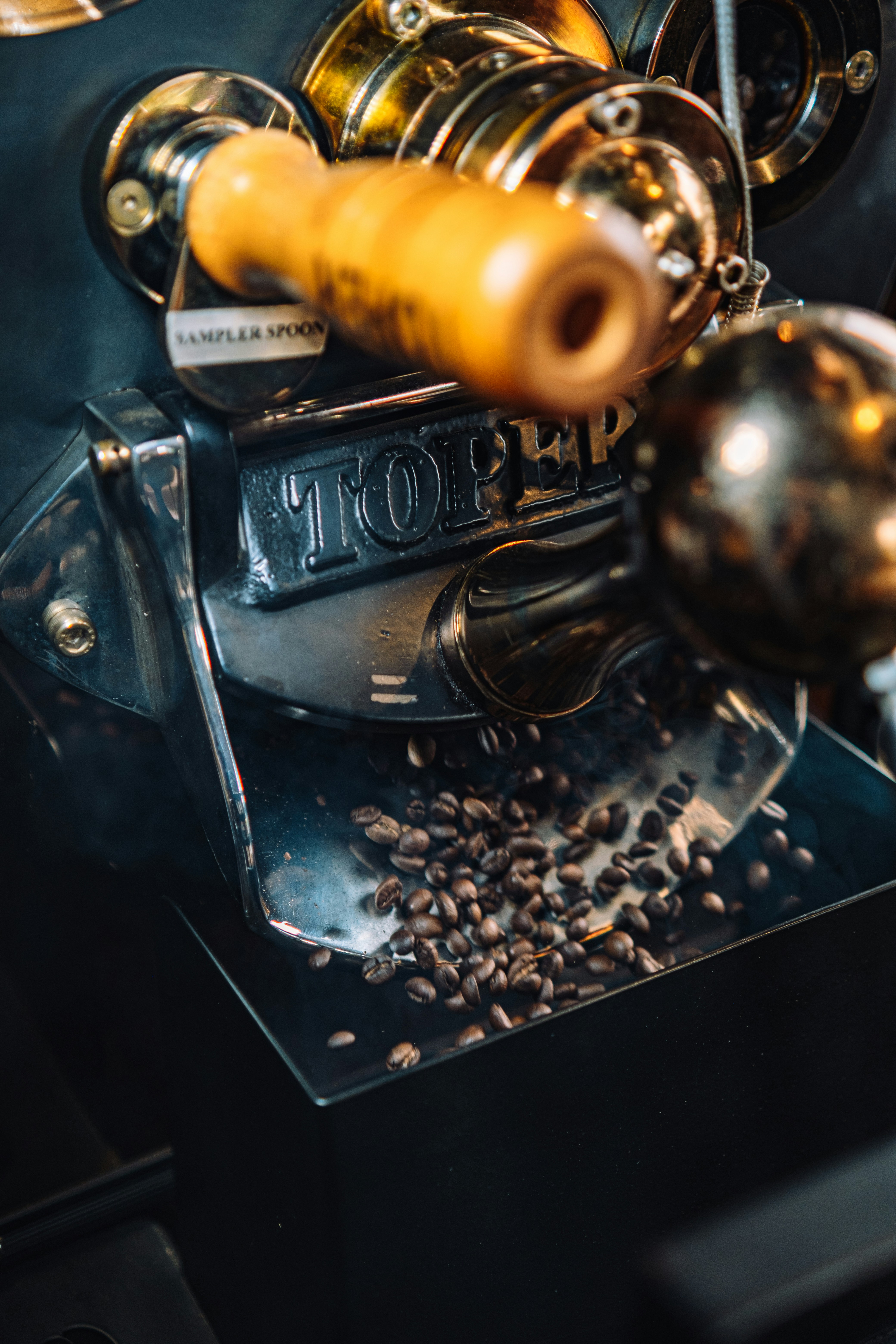 Amber Knob, Teal Cast: Close-Up on an Antique Coffee Grinder