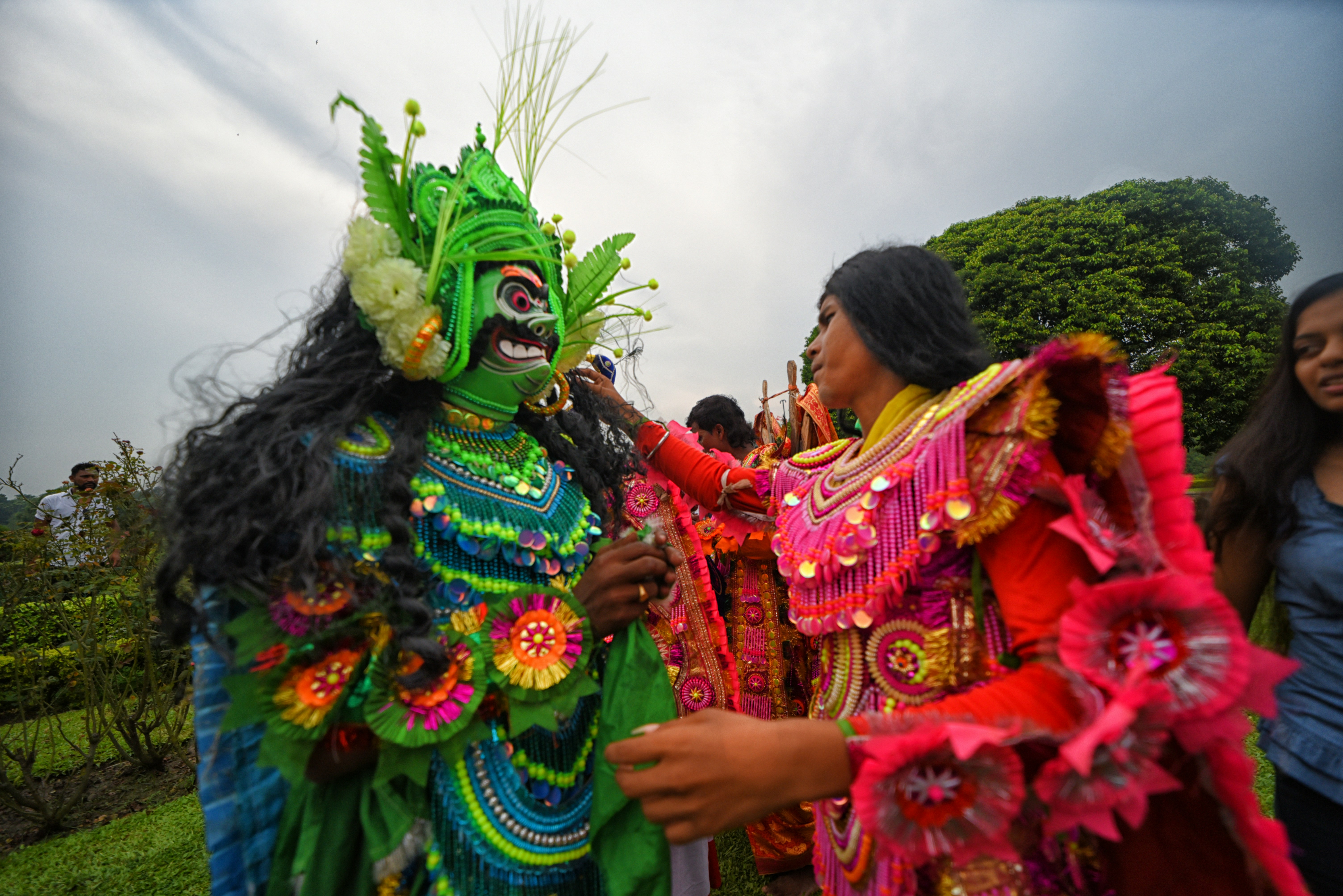 Emerald Masque: Green Warrior Amid a Burst of Festival Color