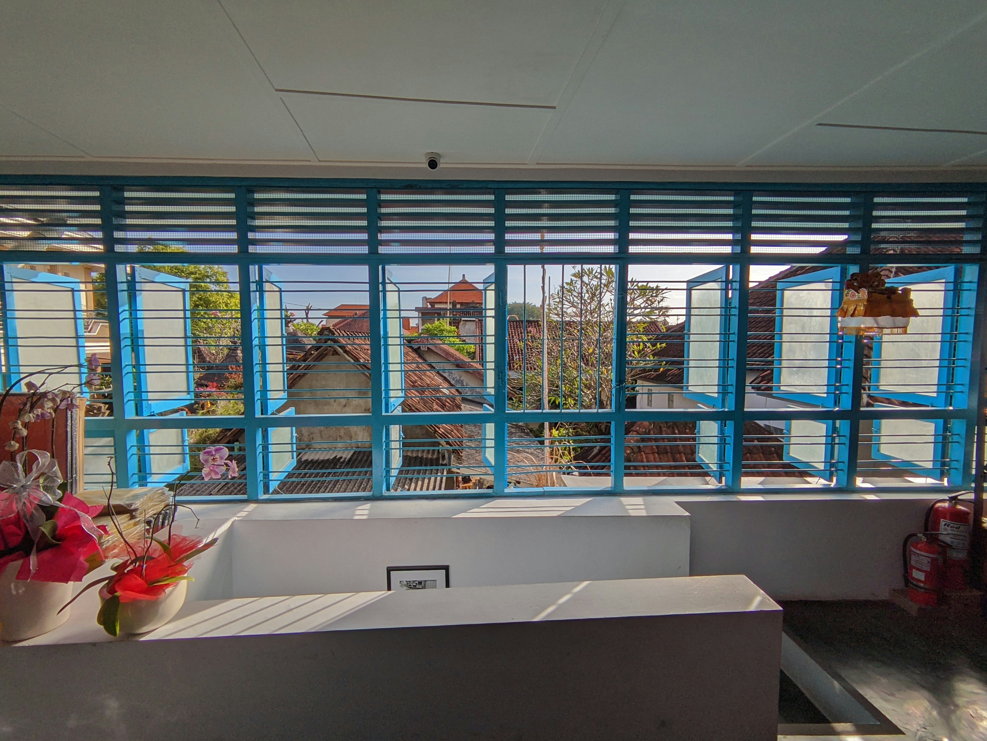 Sunlit Geometry: A View Through Blue-Framed Windows