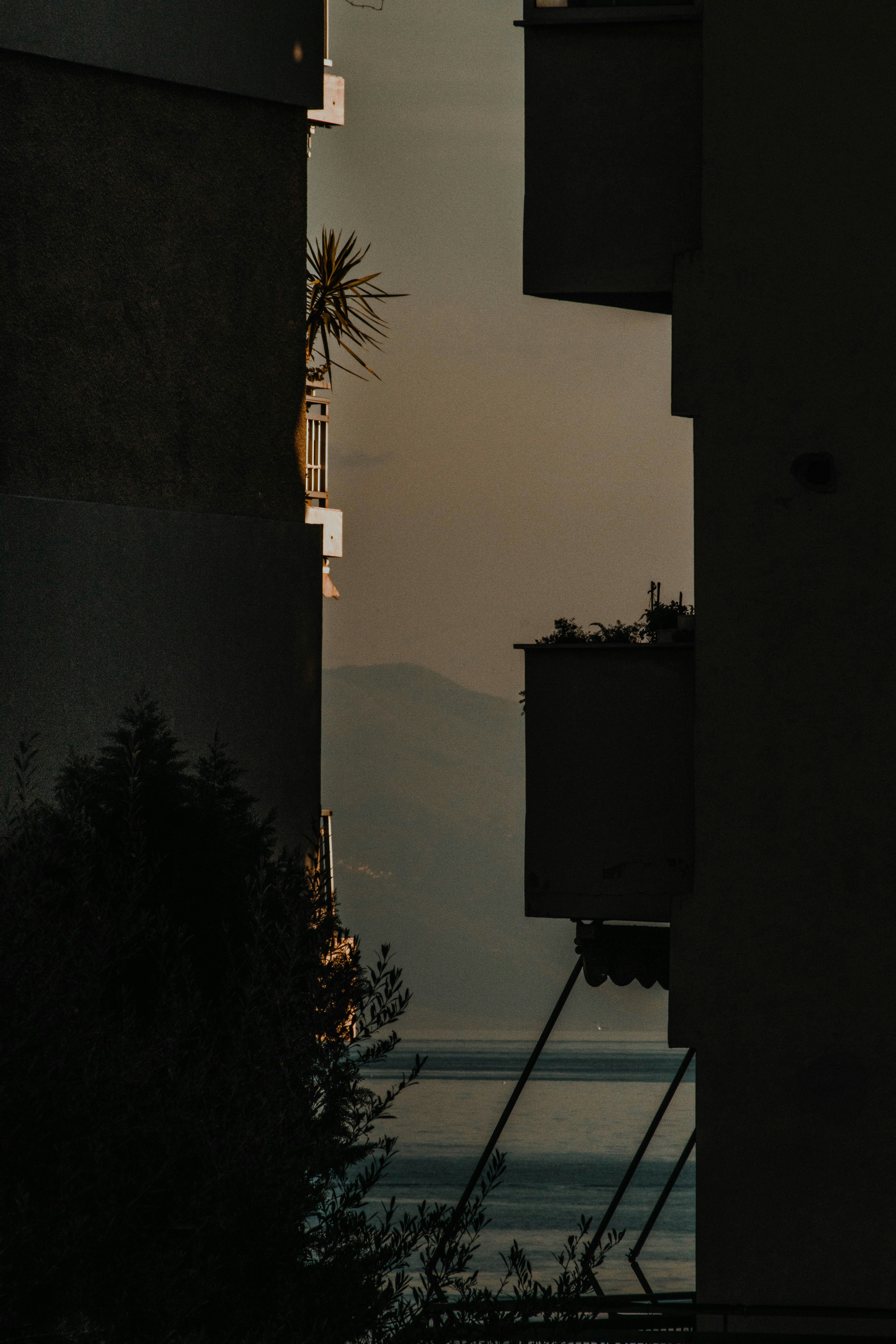 Framed Gap: Sunset Over a Coastal Horizon Between Urban Walls