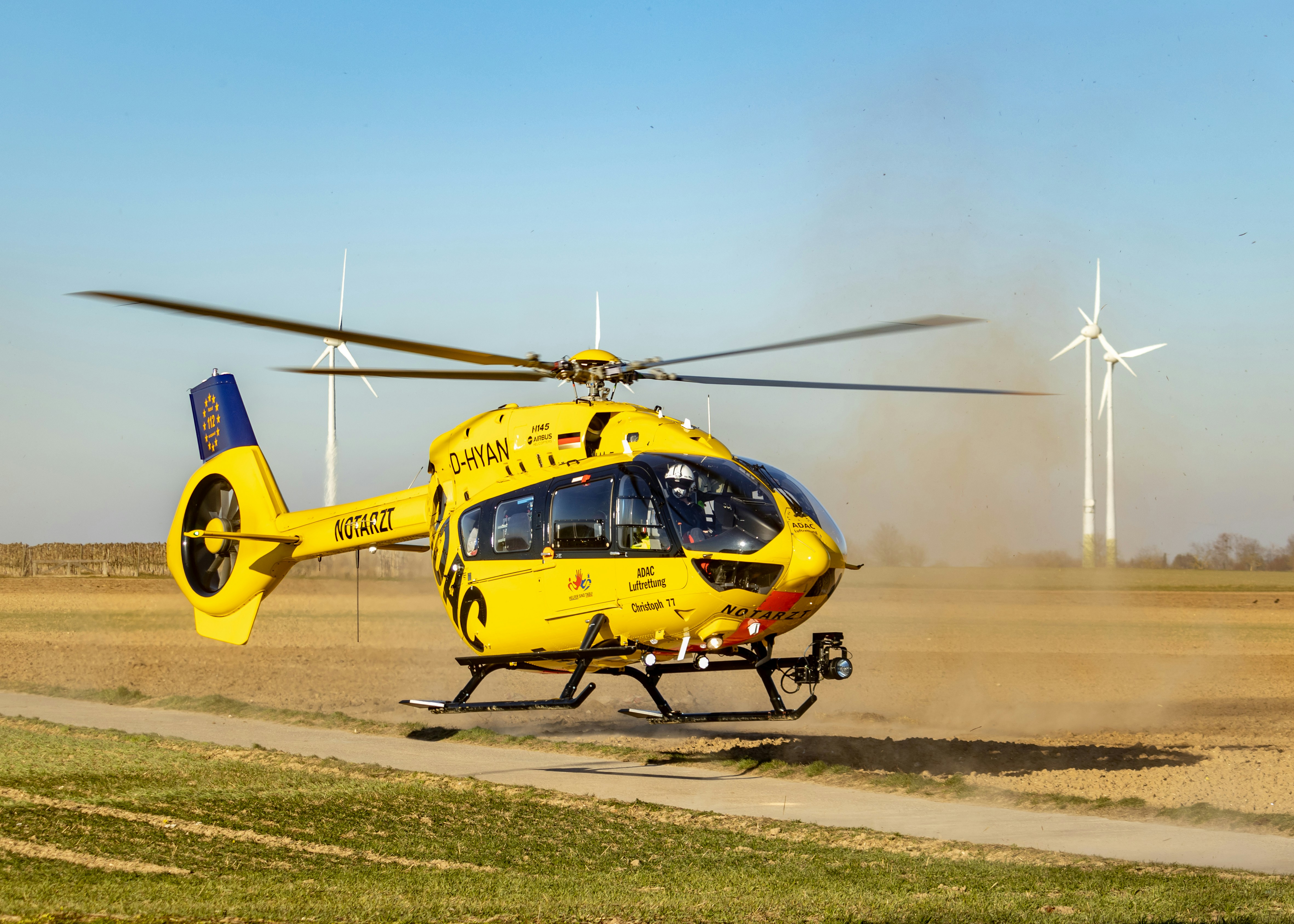 a yellow helicopter on a field