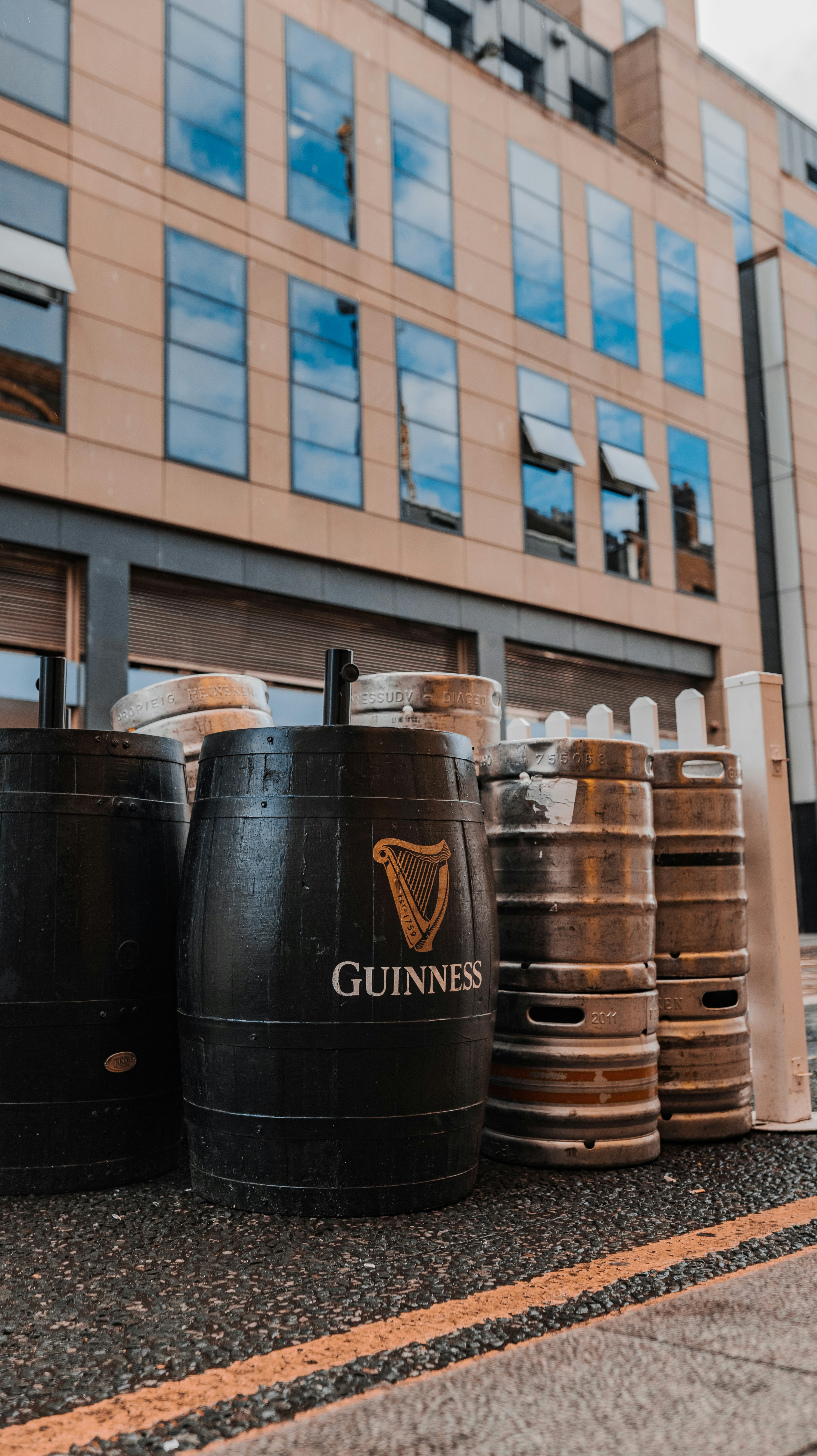 A group of barrels outside of a building photo – Free Building Image on ...