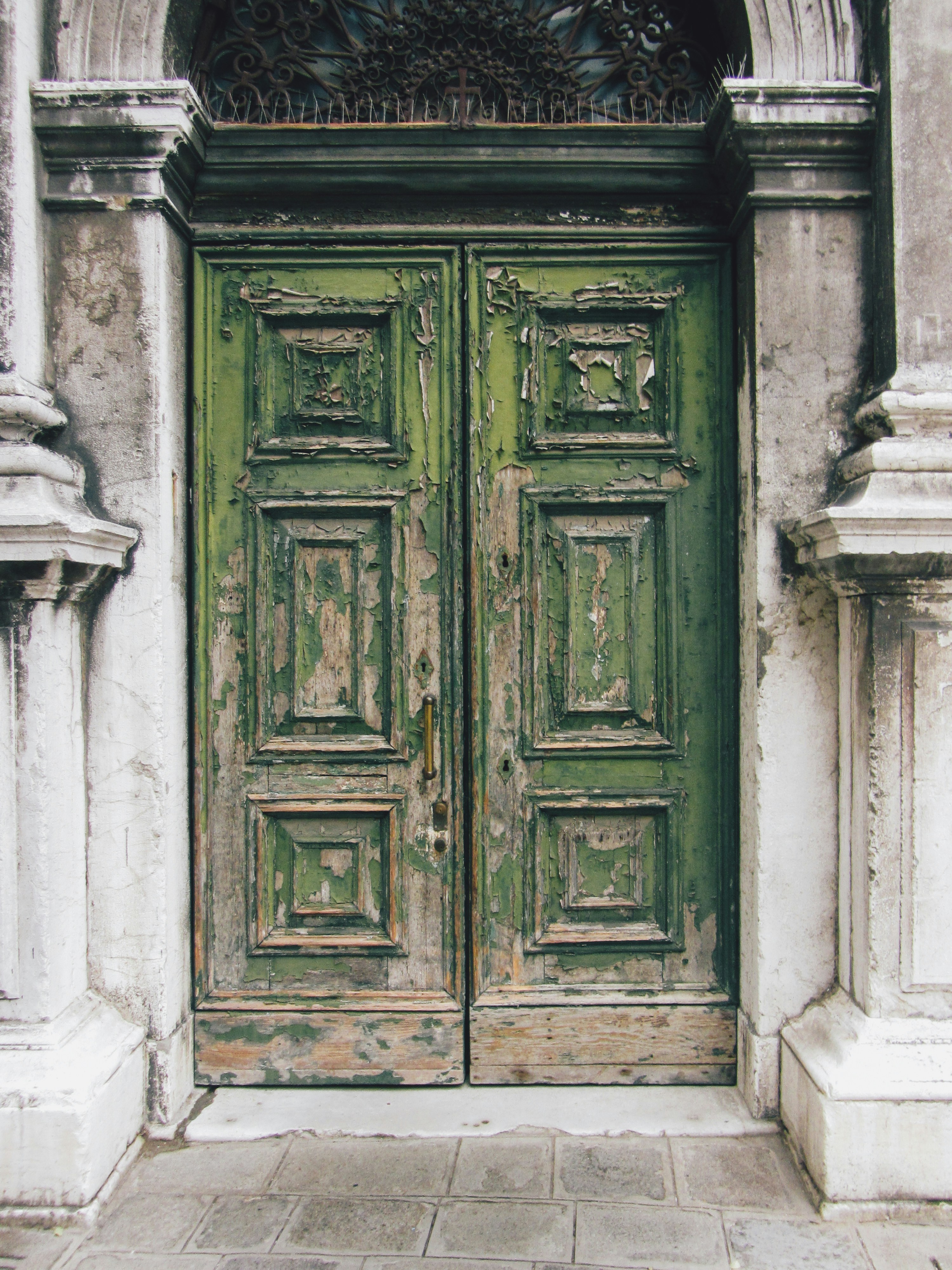 Peeling green door in Venice