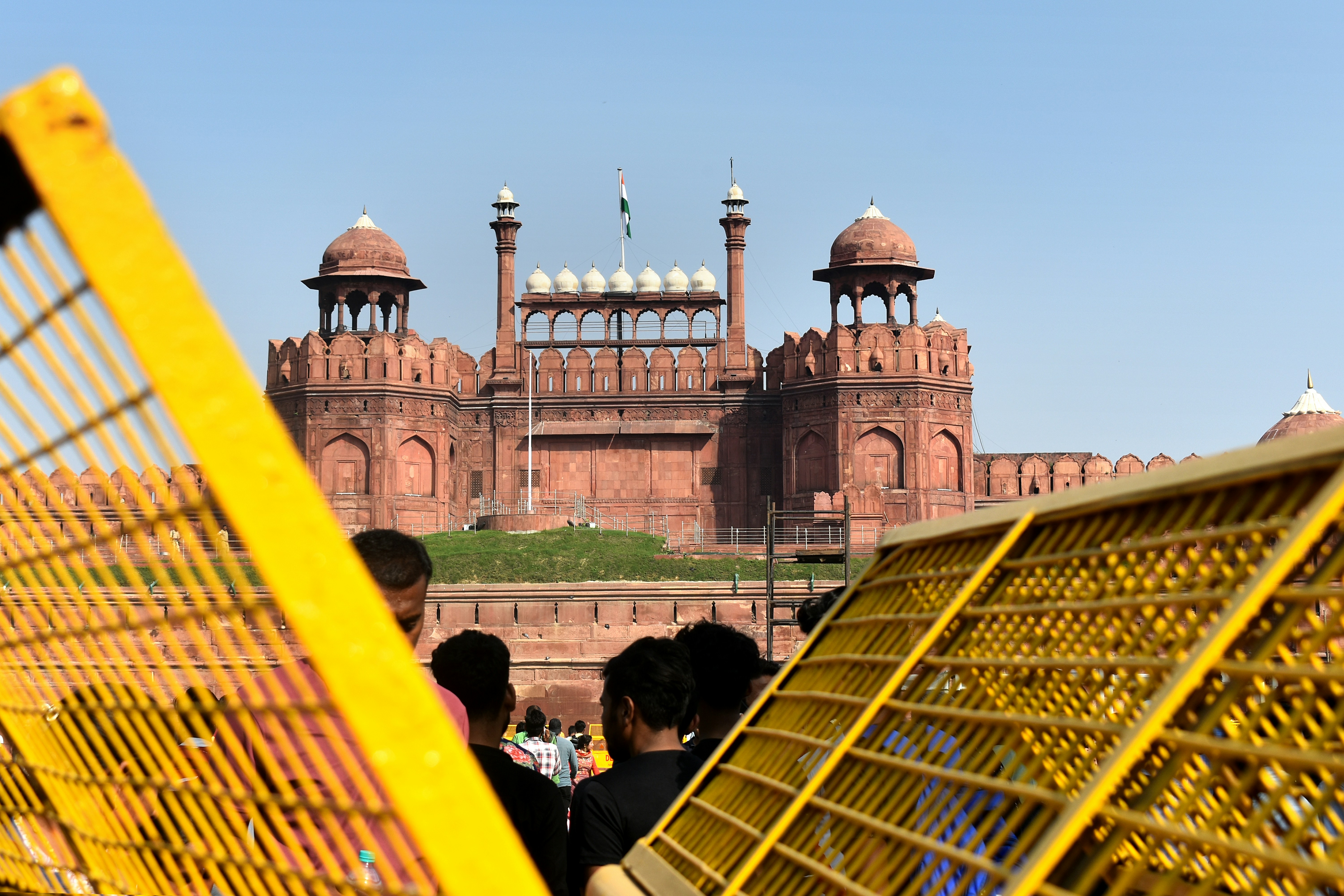 A large building with a domed roof with Red Fort in the background ...