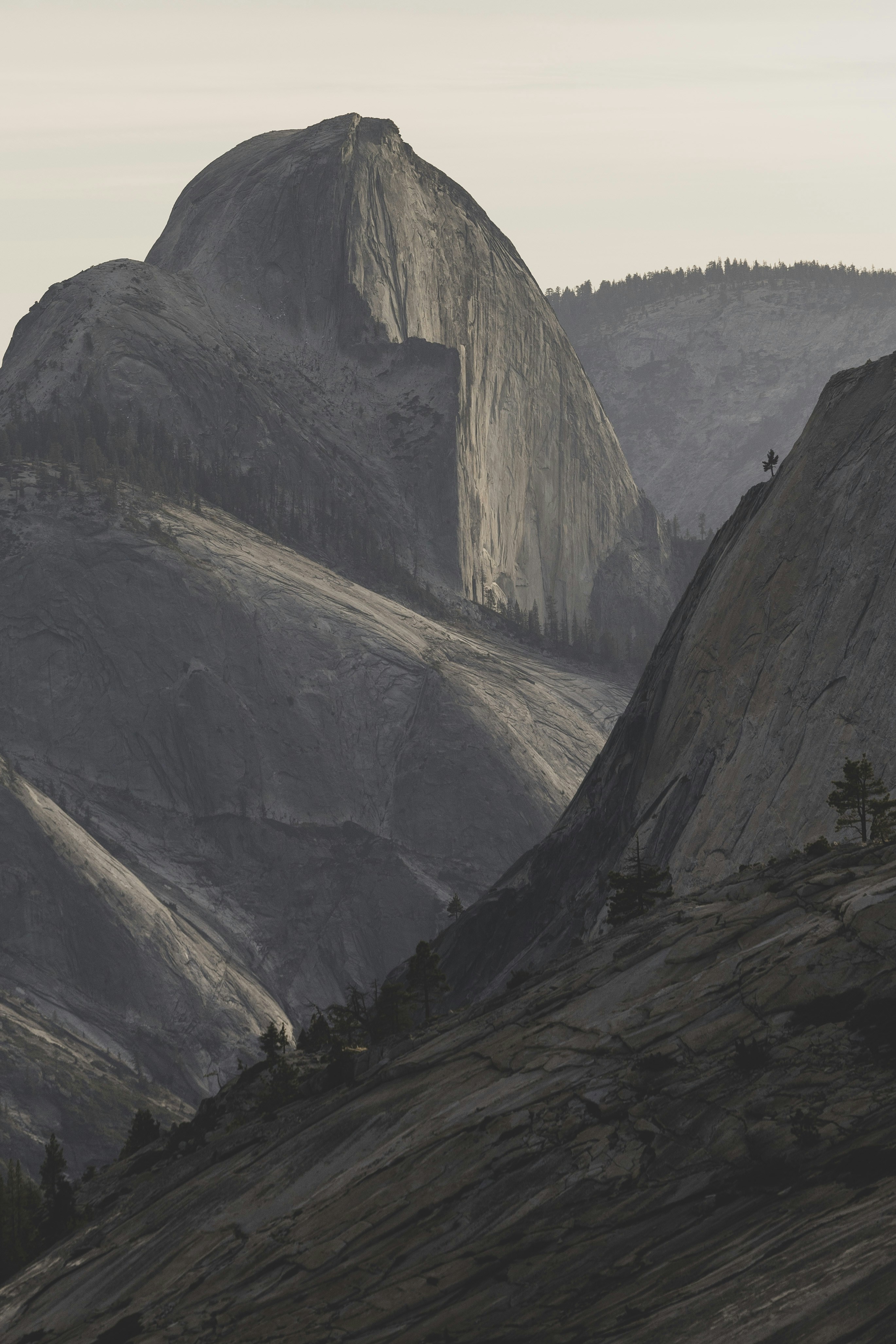 Monolithic Peak Across Quiet Valleys at Dusk