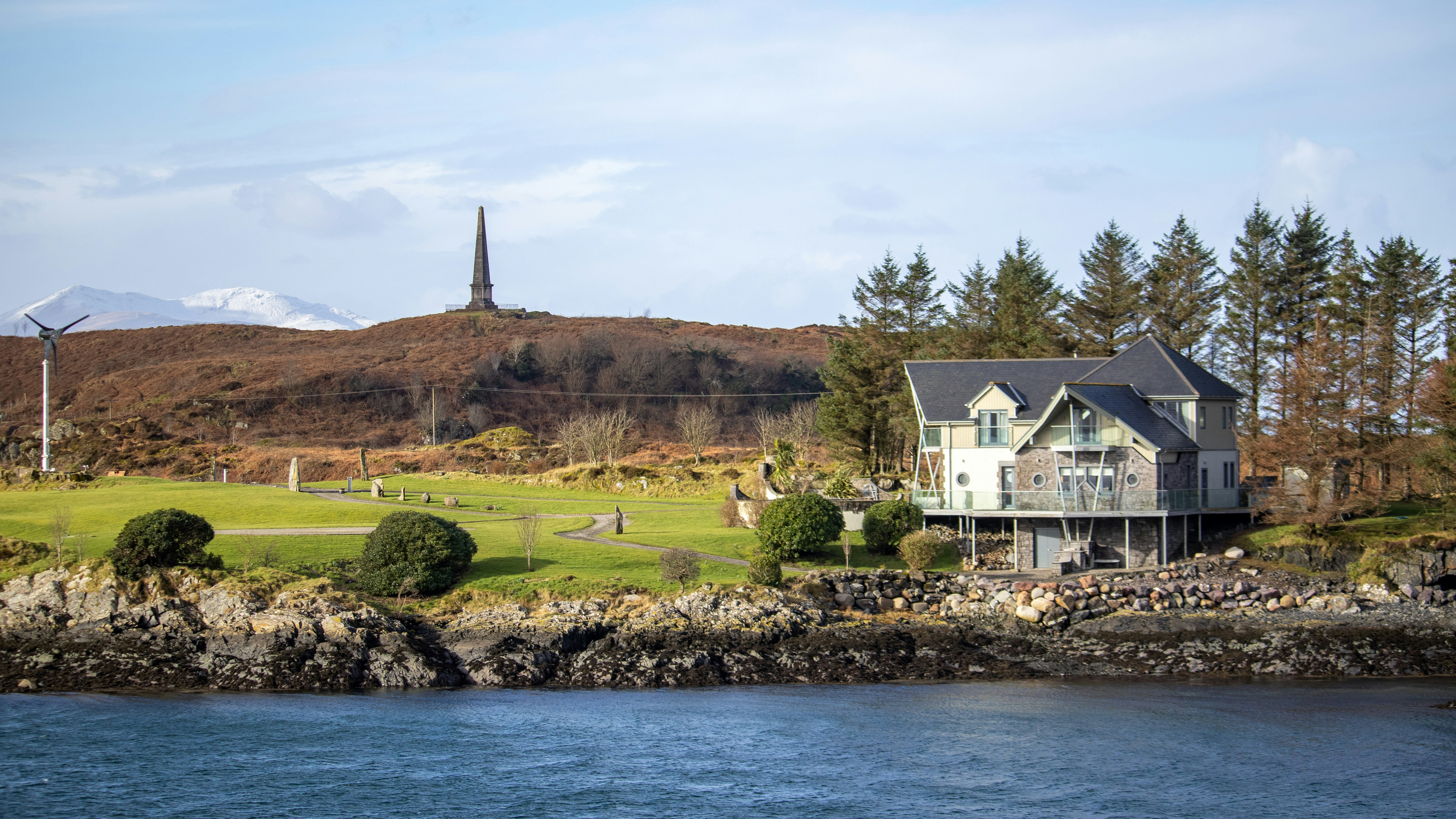 A house on a hill by a body of water photo – Free Kerrera Image on Unsplash