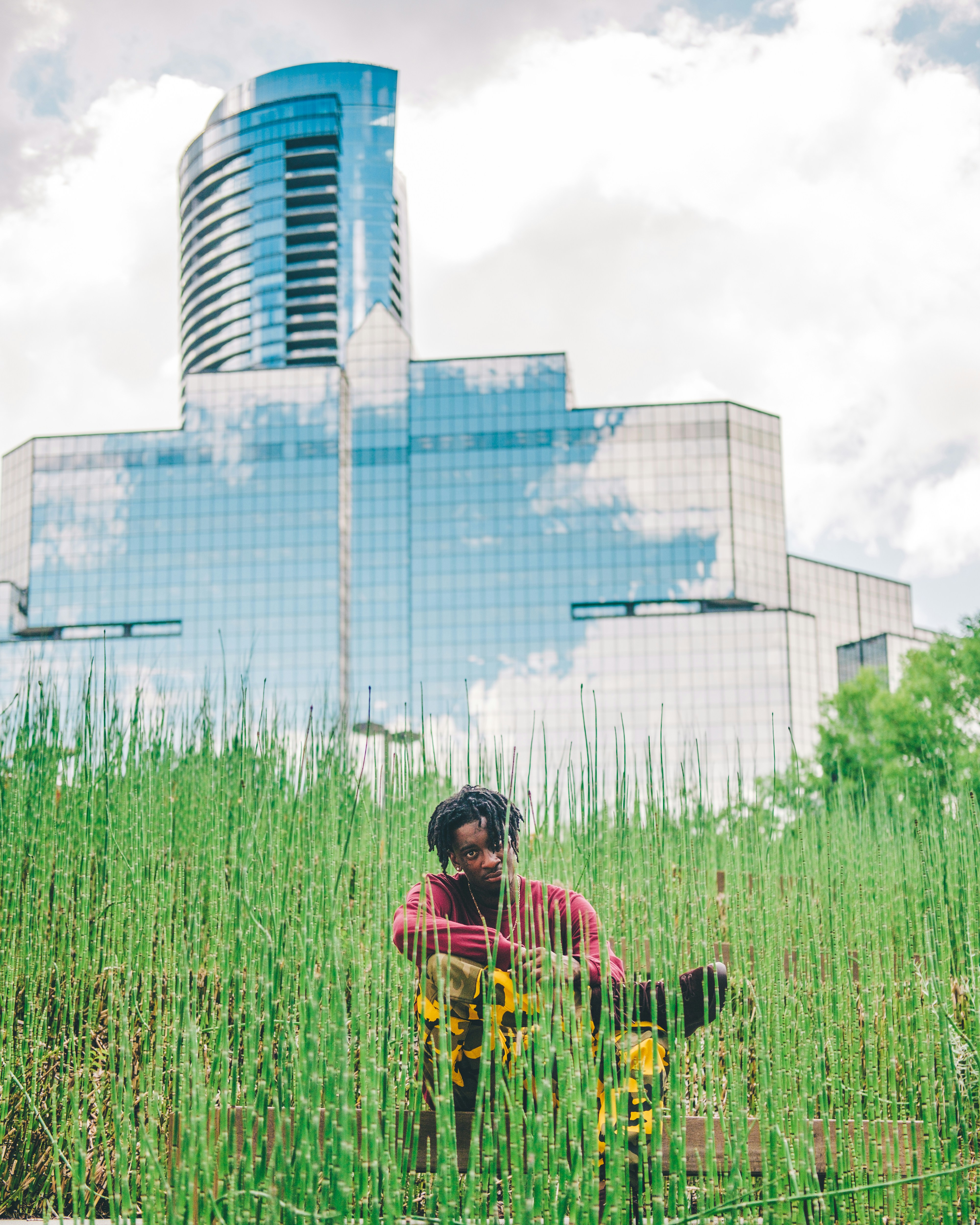 Portrait in the Grass Between Glass Skyscrapers