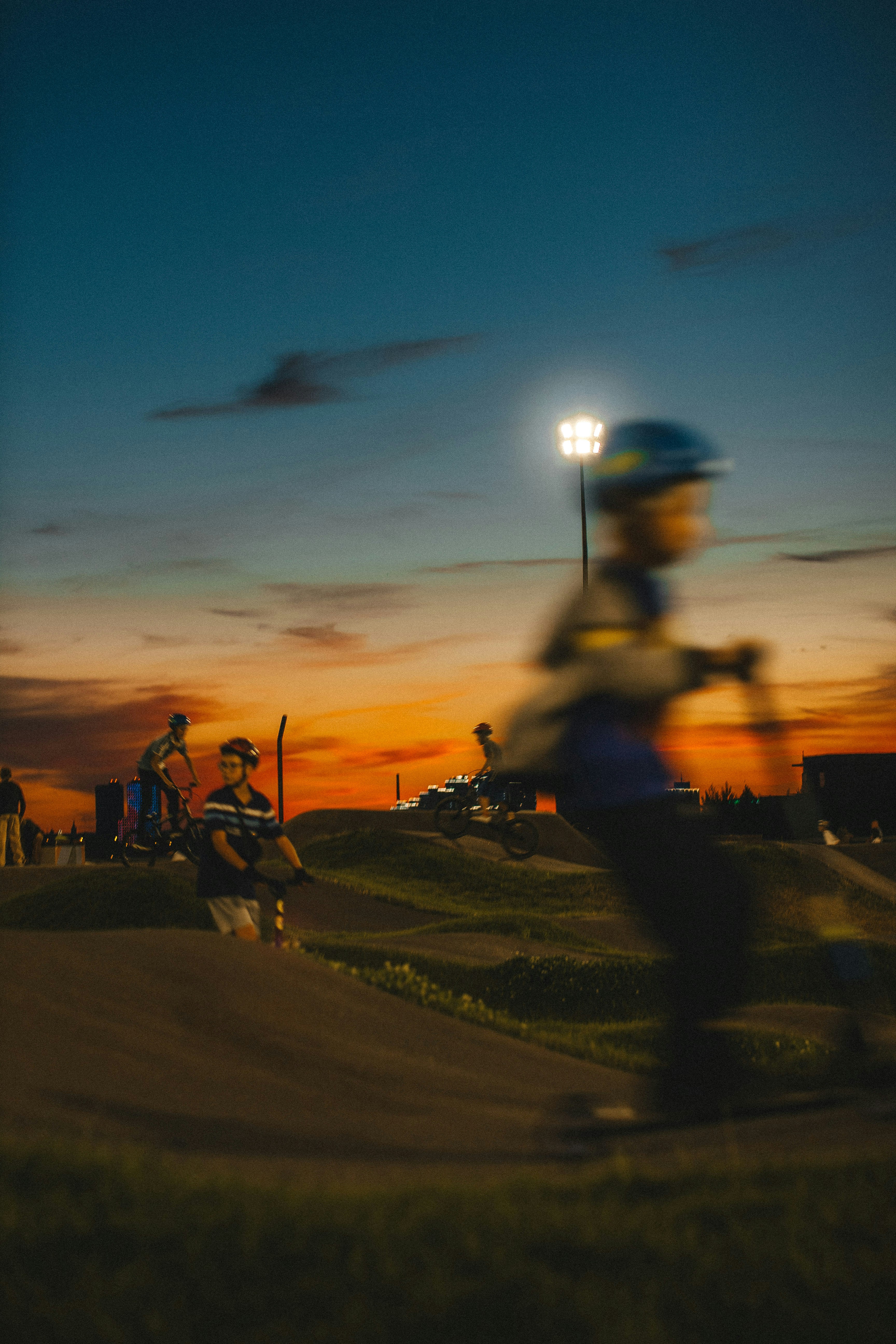 Sunset Velocity: Blur of Riders Across a Quiet Skate Park