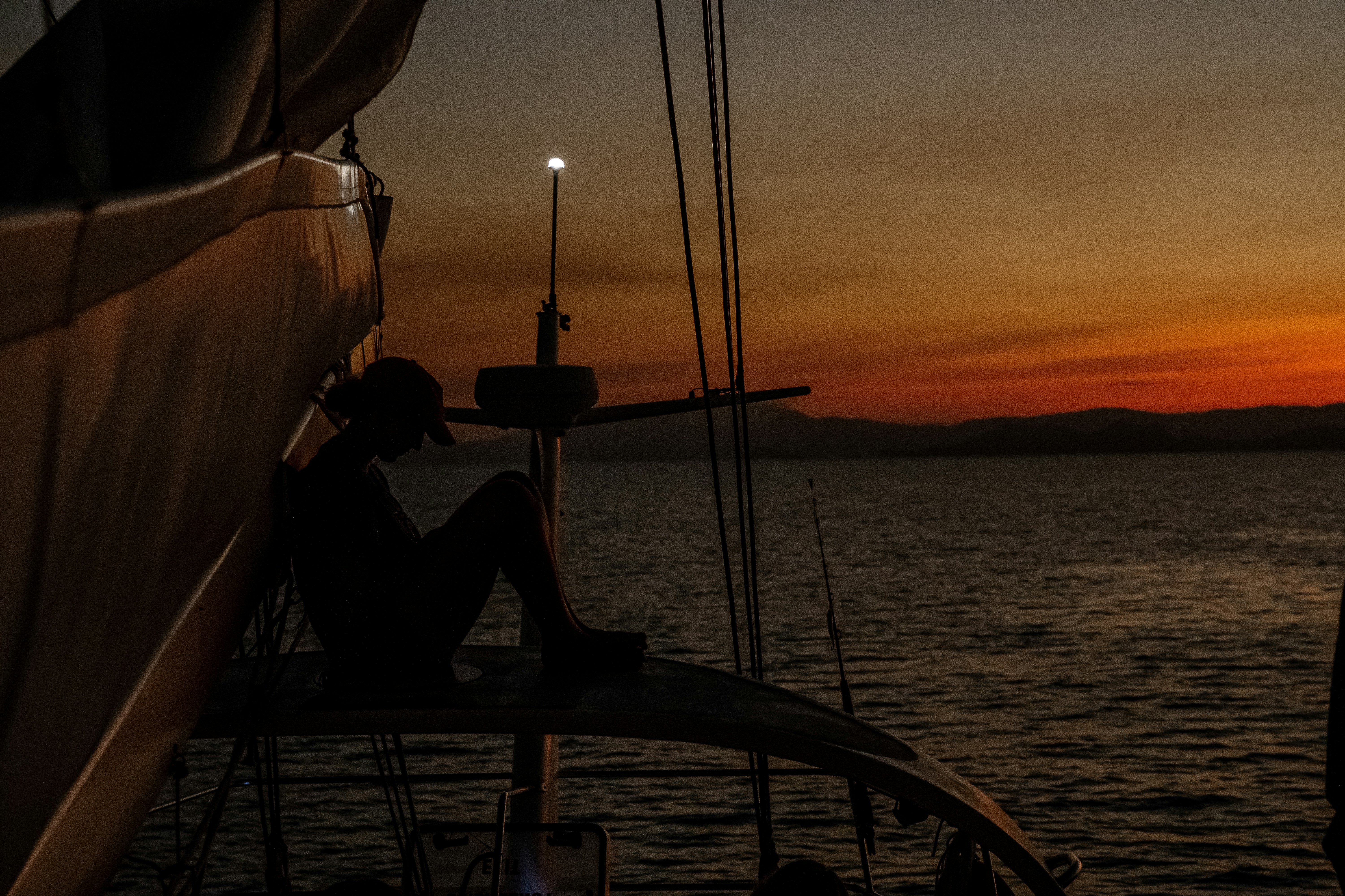 Hushed Dusk Afloat: Silhouette Pause on a Sailboat
