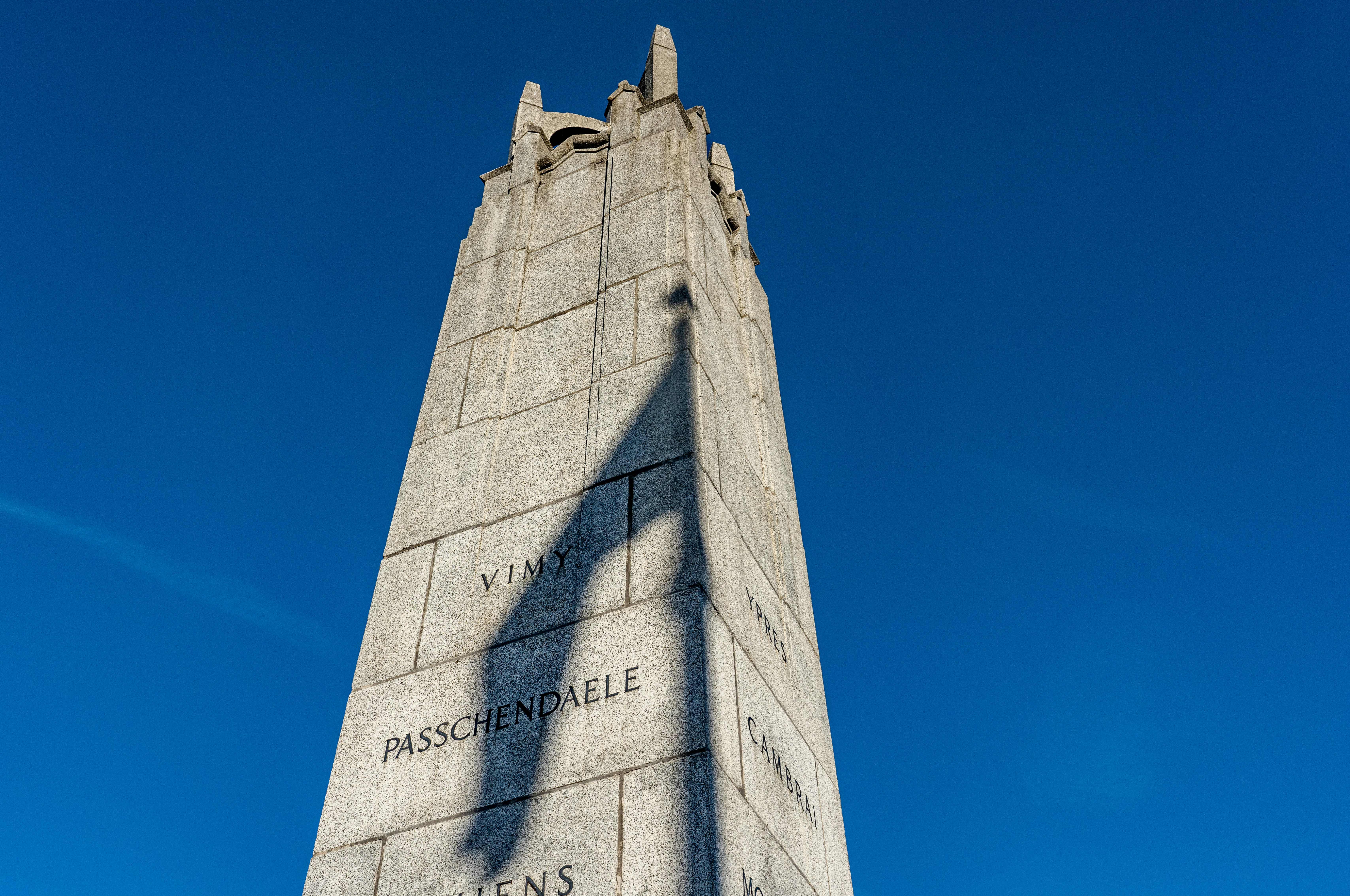 cenotaph with the shadow of a flag on it