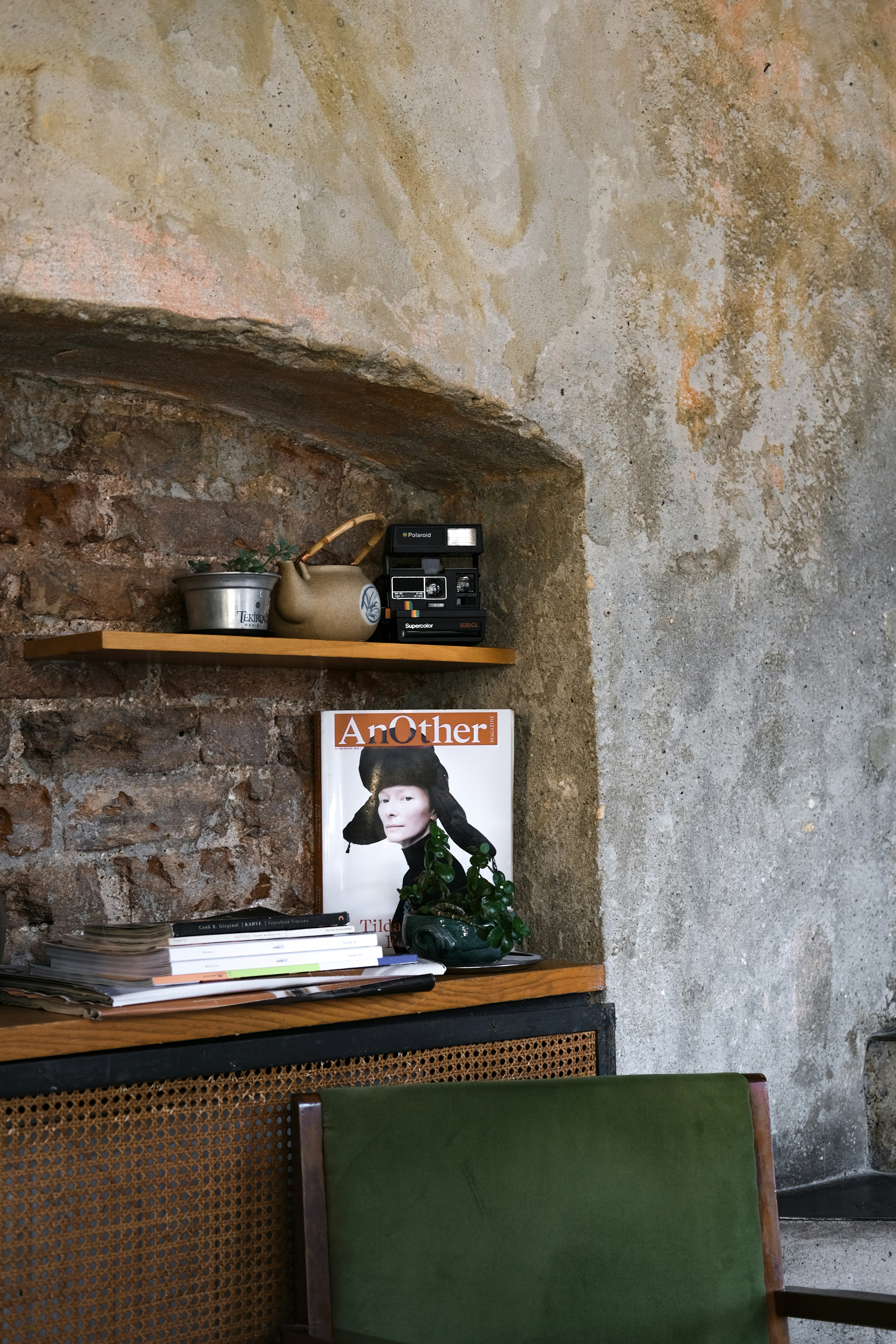 A picture of a person on a shelf next to a book and a camera photo ...