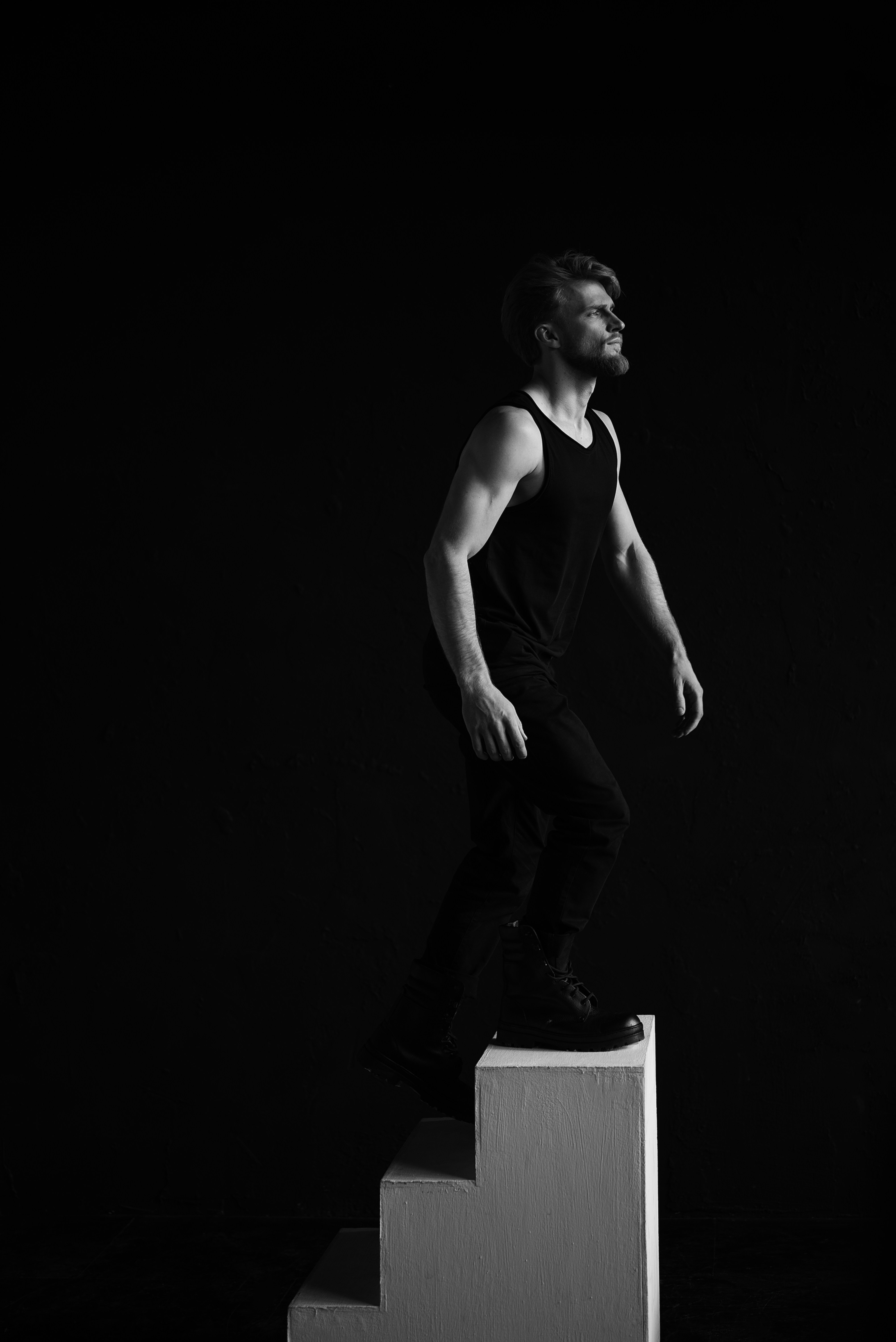 Silhouette Ascent: A lone figure rises on a stark white staircase
