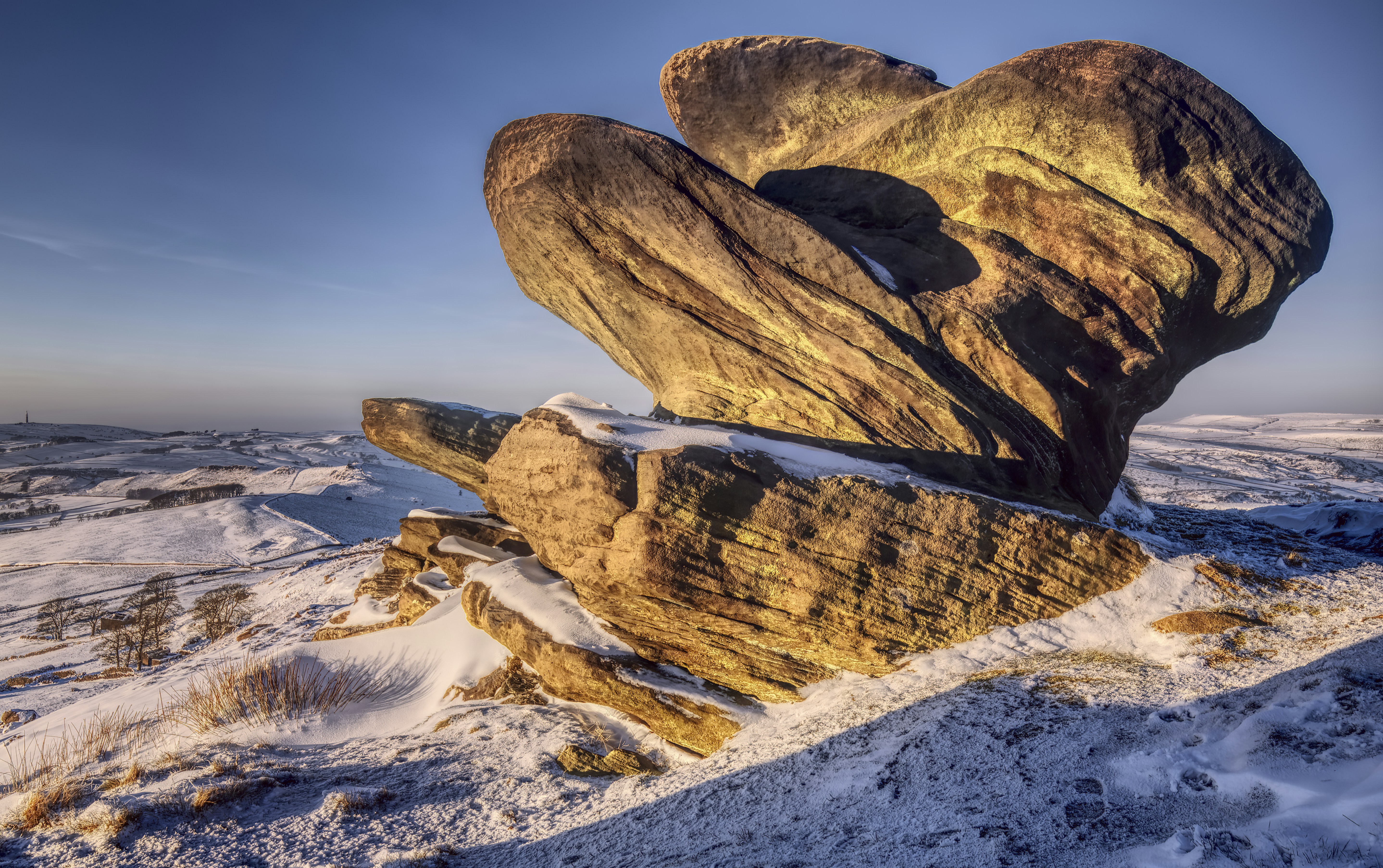 The Frostbound Sentinel: A Weathered Rock Stack on a Snow-Cleared Horizon