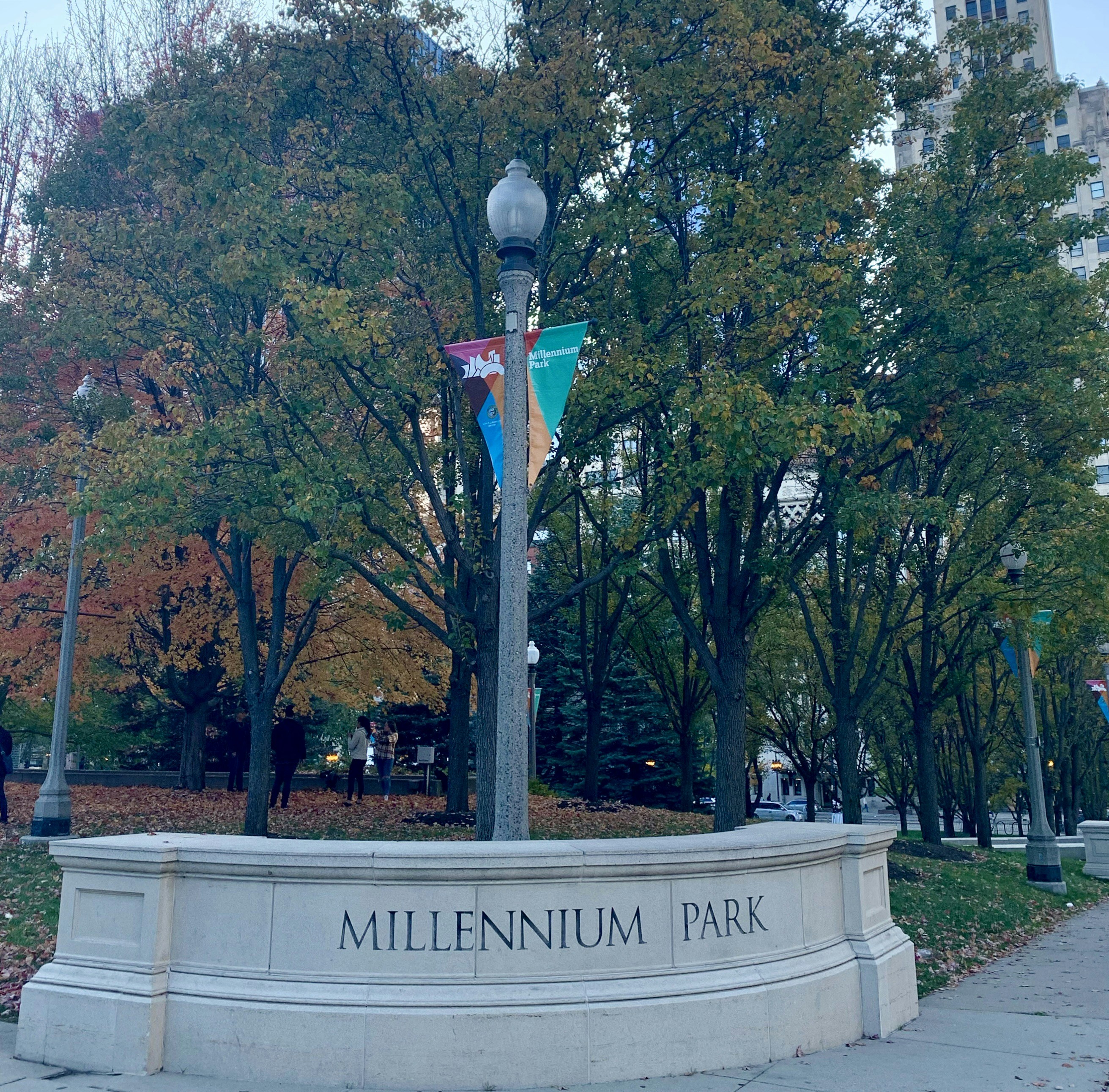 Autumn Canopy and Bannered Lanterns Framing Millennium Park's Stone Seat