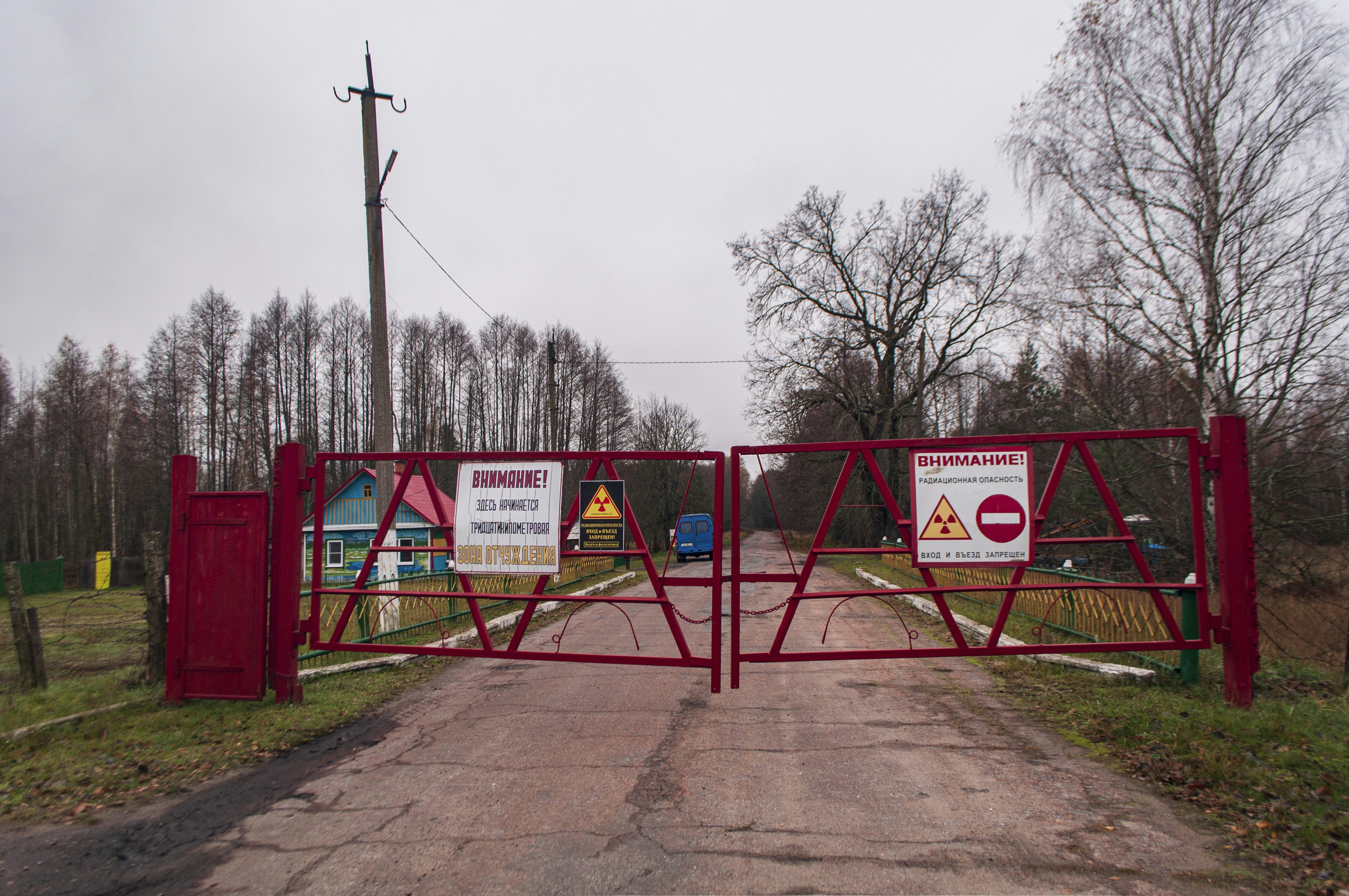 A red gate with signs on it photo – Free Chernobyl zone Image on Unsplash
