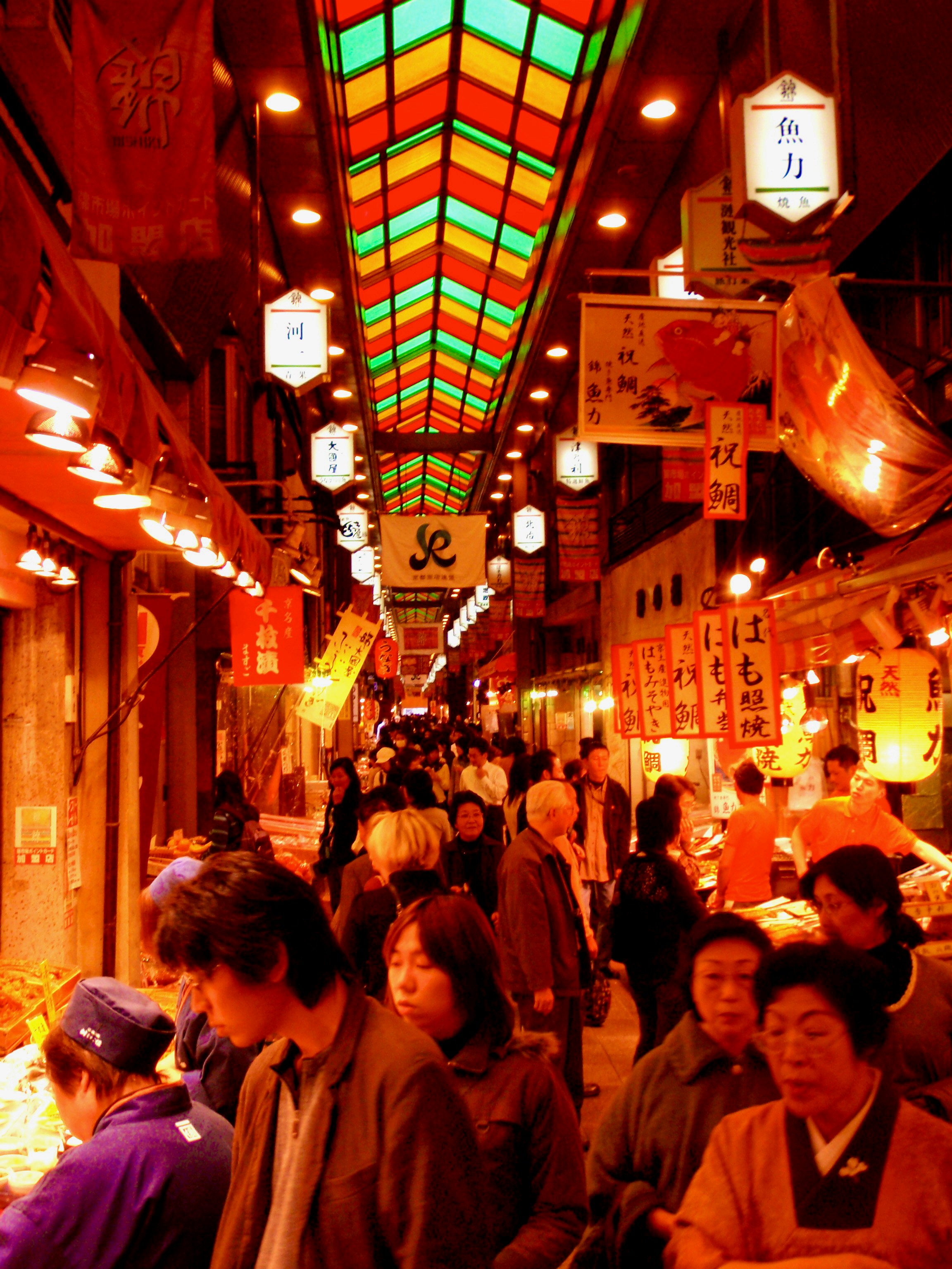 Kyoto alley by Kate Branch | a crowd of people walking through a busy street