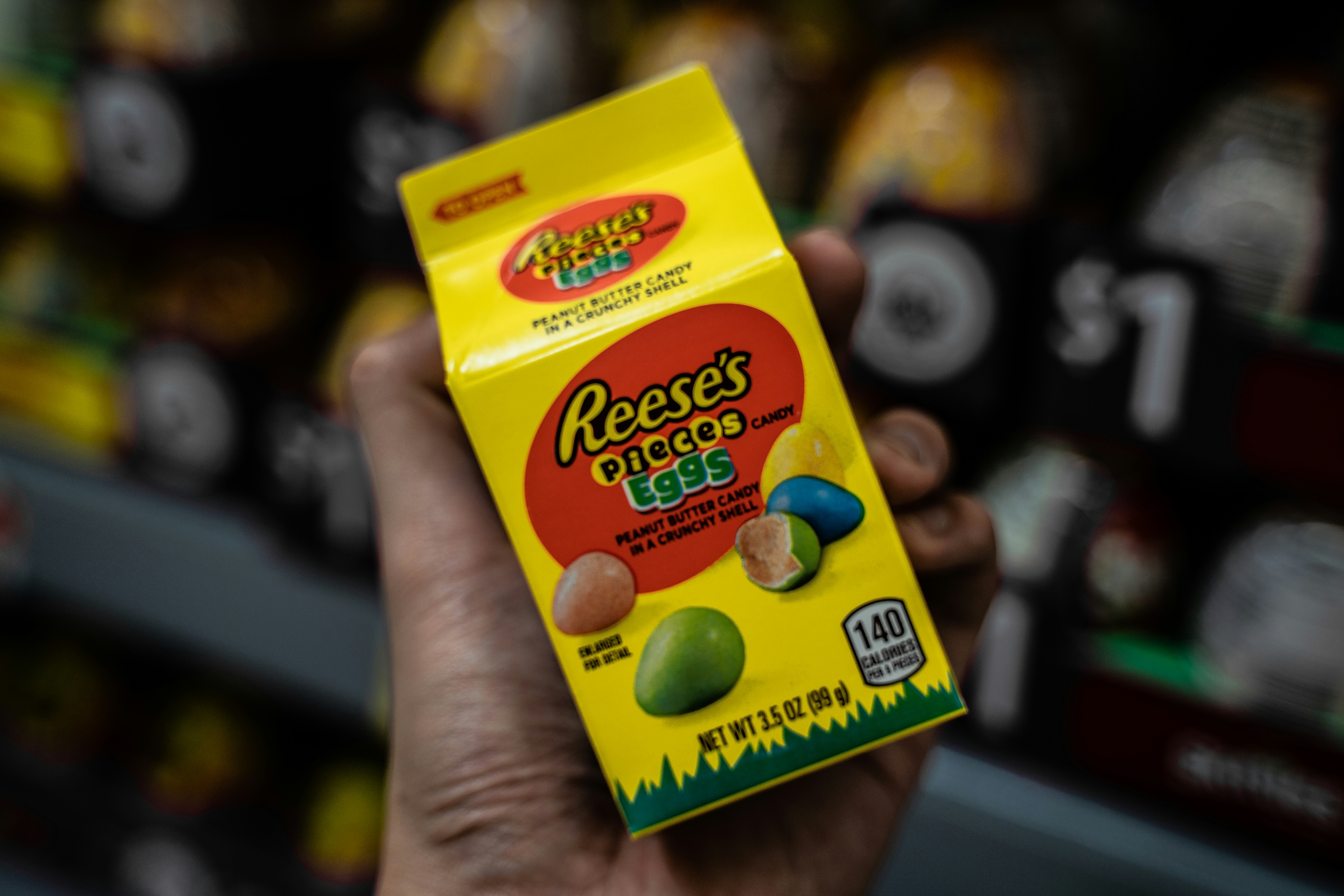 A hand holding a yellow and green box of candy photo – Free Food Image ...