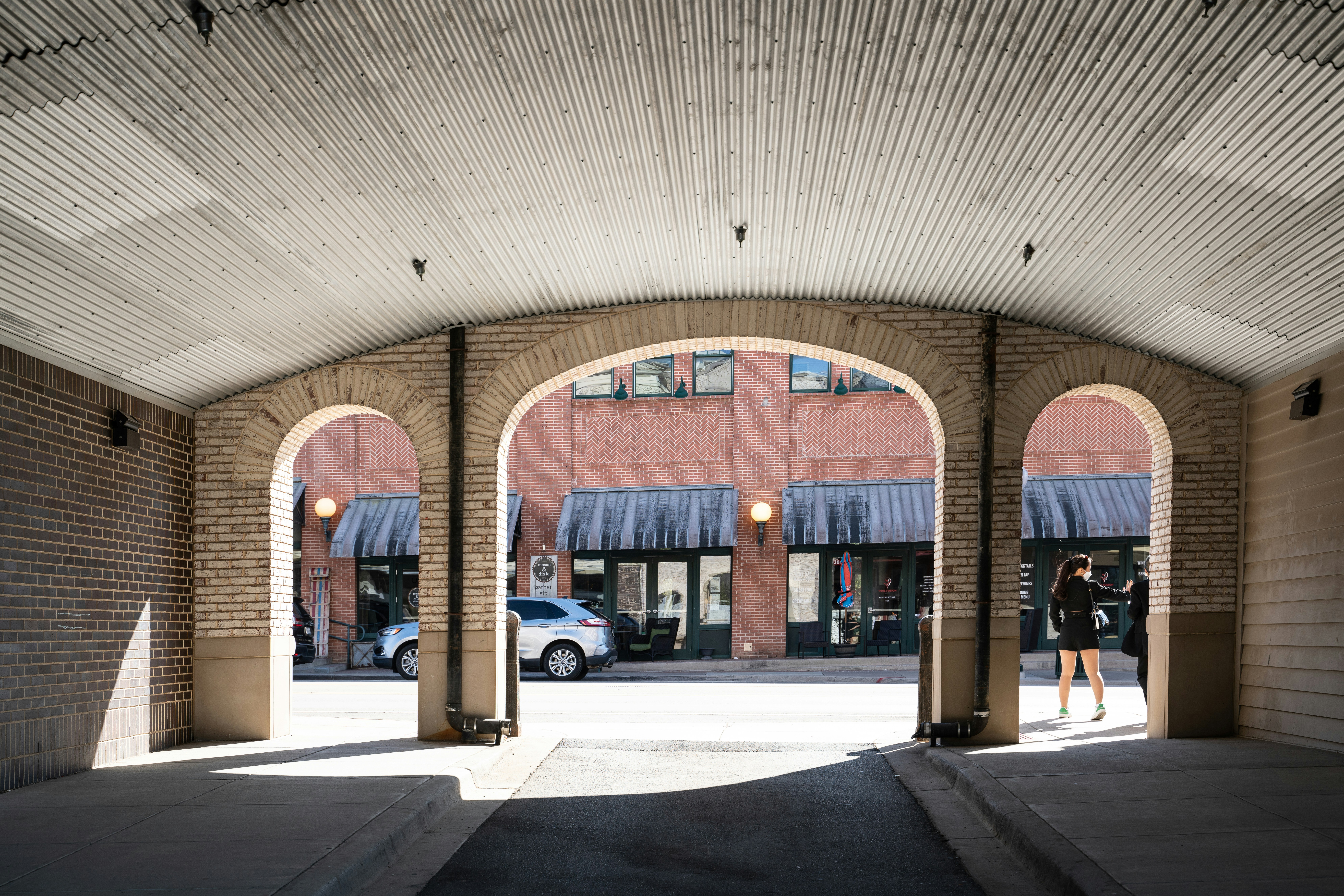 Sunlit Arcade Through Brick Arches