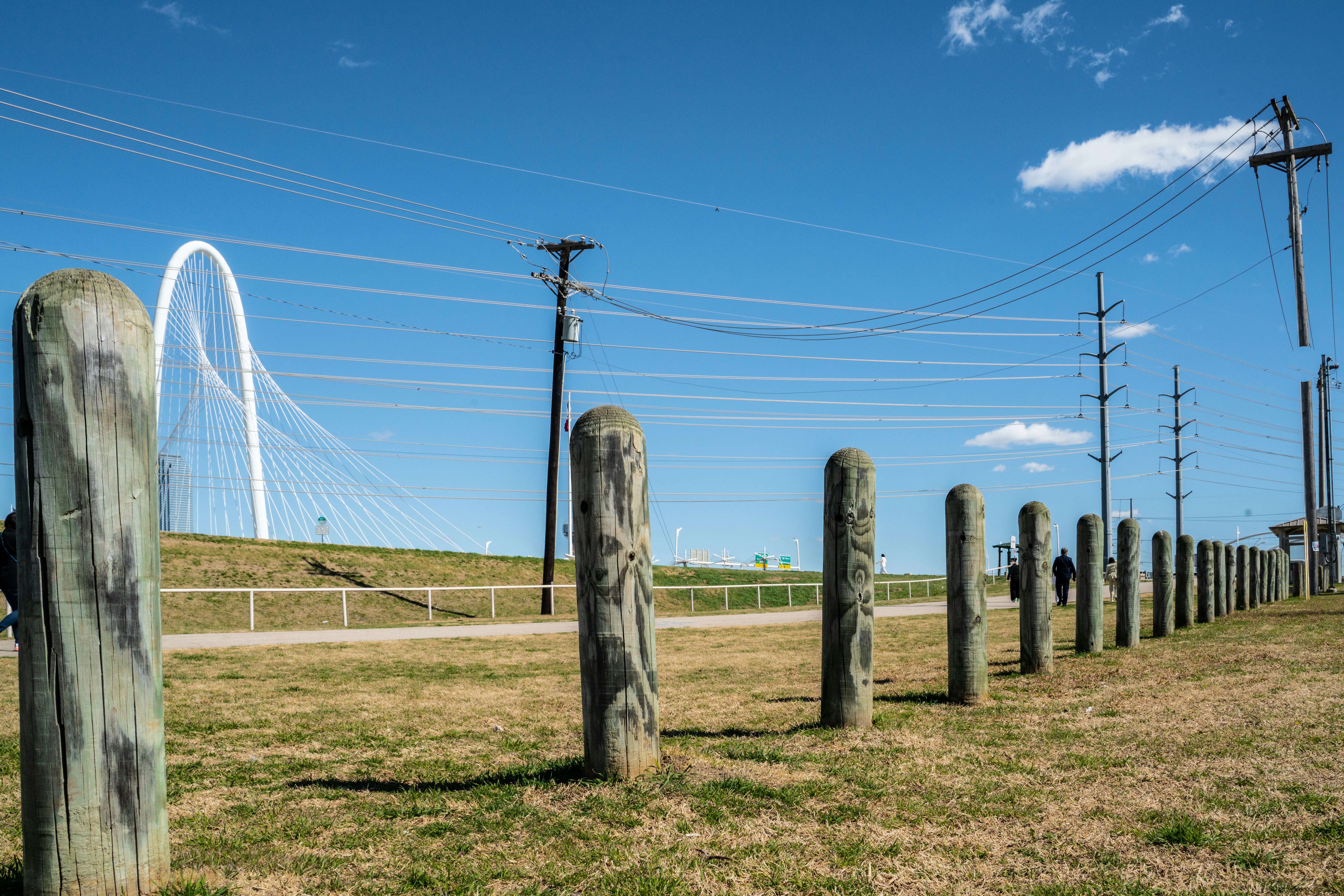 A fenced off field with power lines and poles photo – Free Utility pole ...