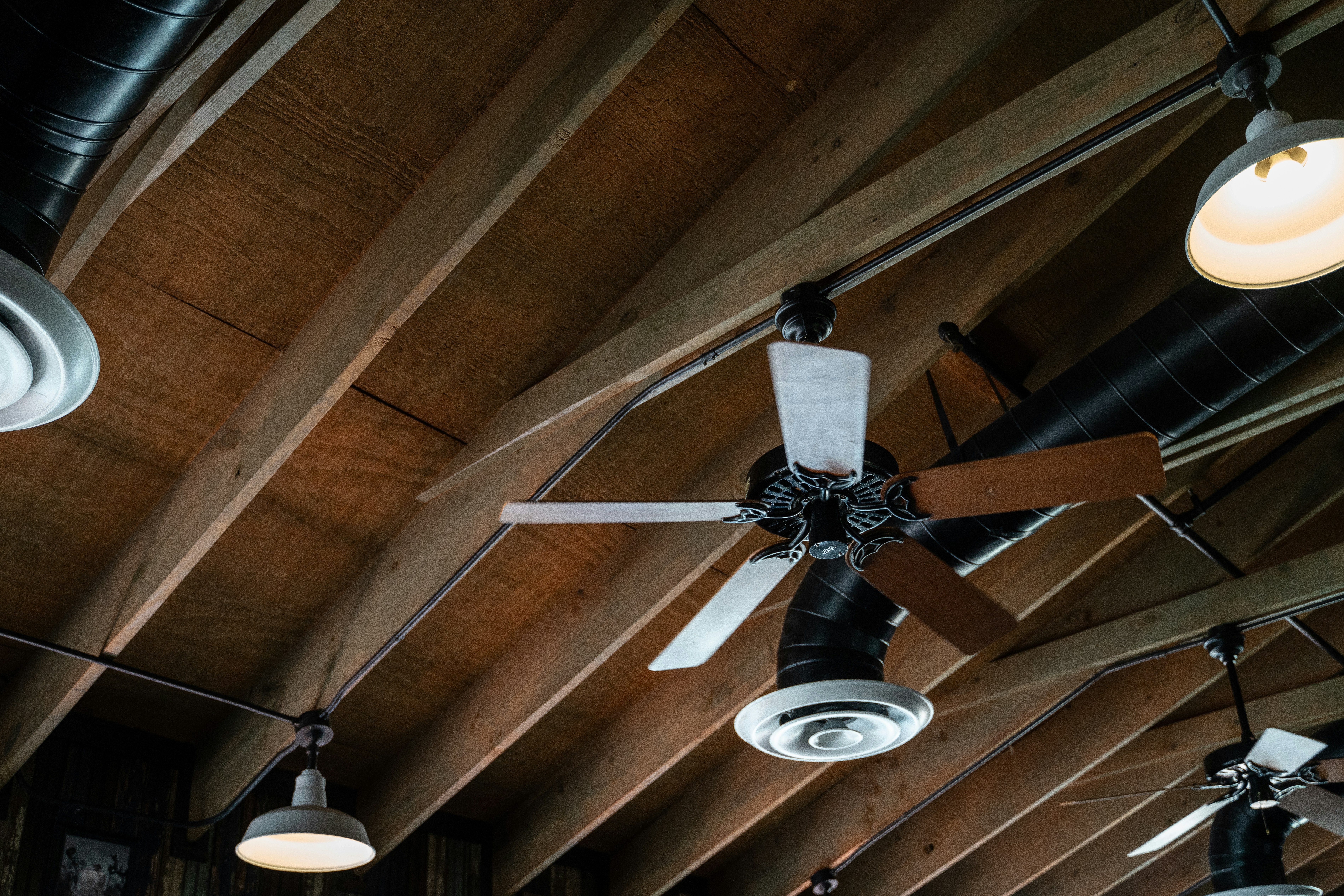 Ceiling Beams and Fans in a Rustic Studio Roof