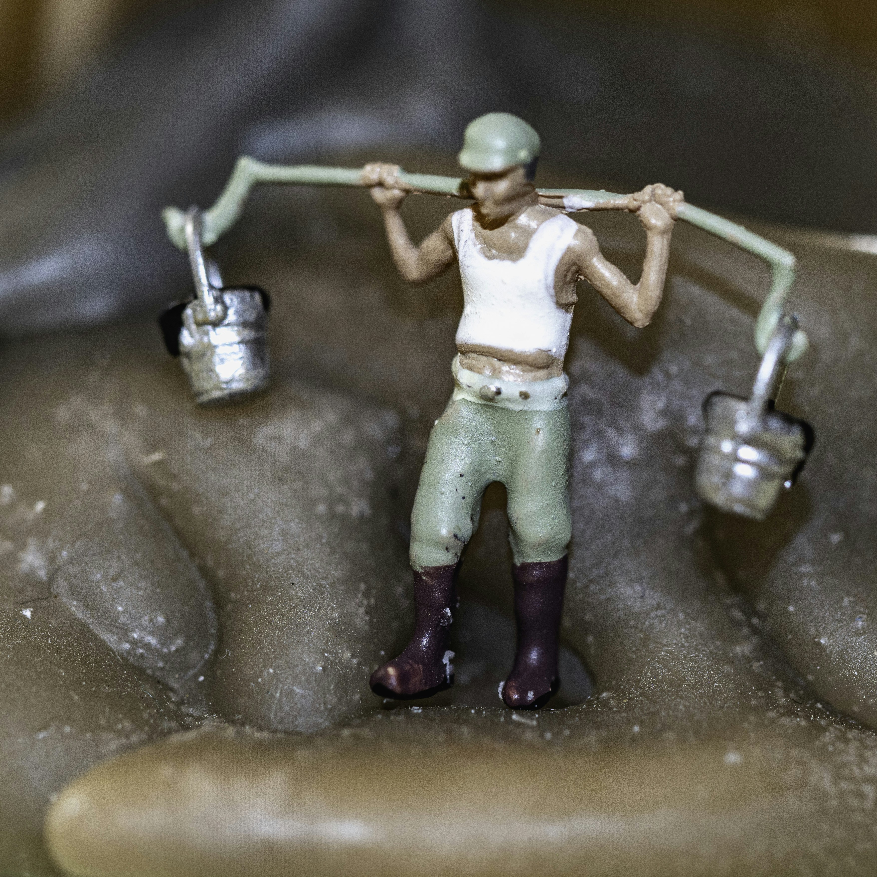 Microweight Lifter: A Macro Portrait of a Tiny Plastic Weightlifter on a Textured Surface