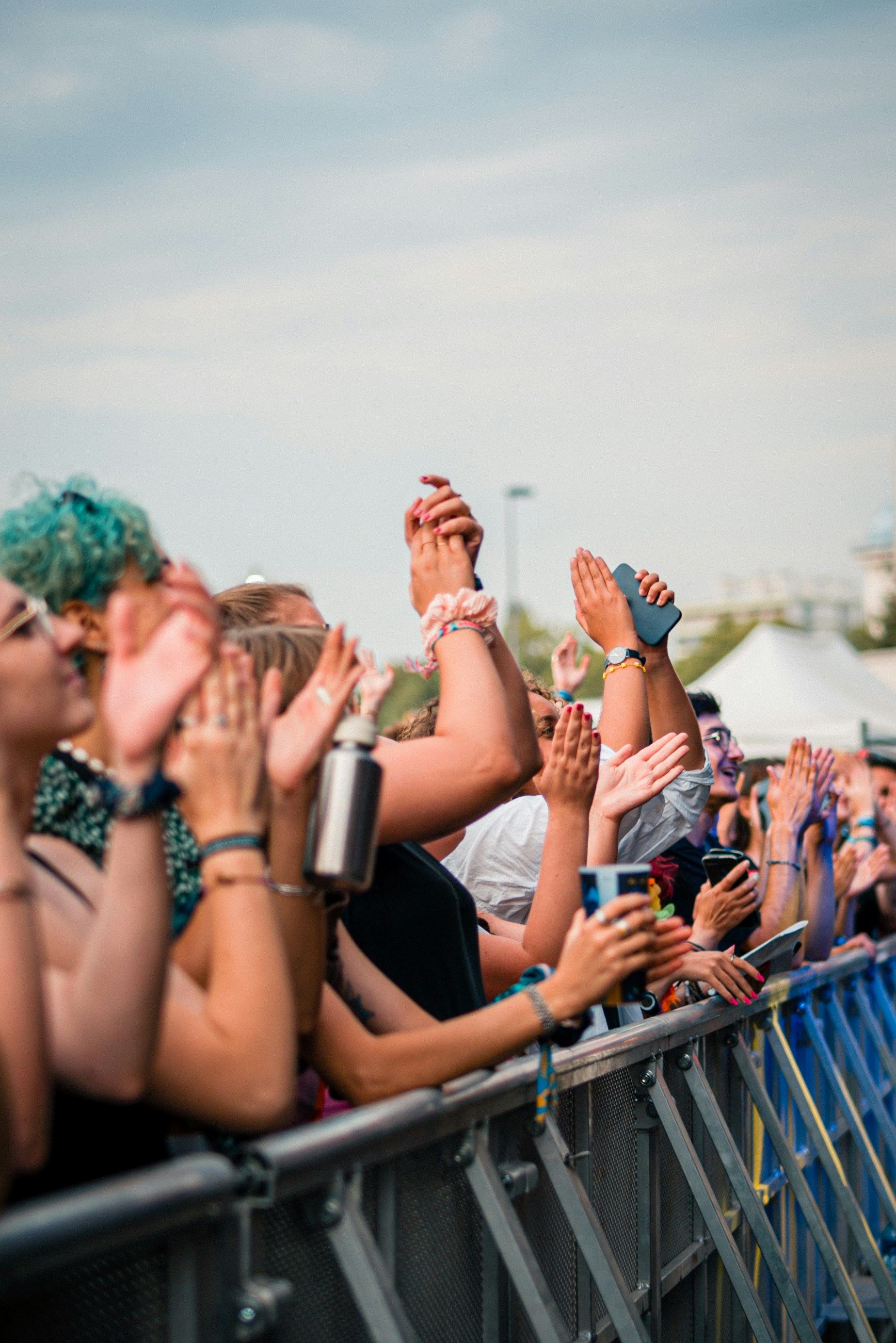 Raised Hands at the Barrier: A Crowd's Shared Moment