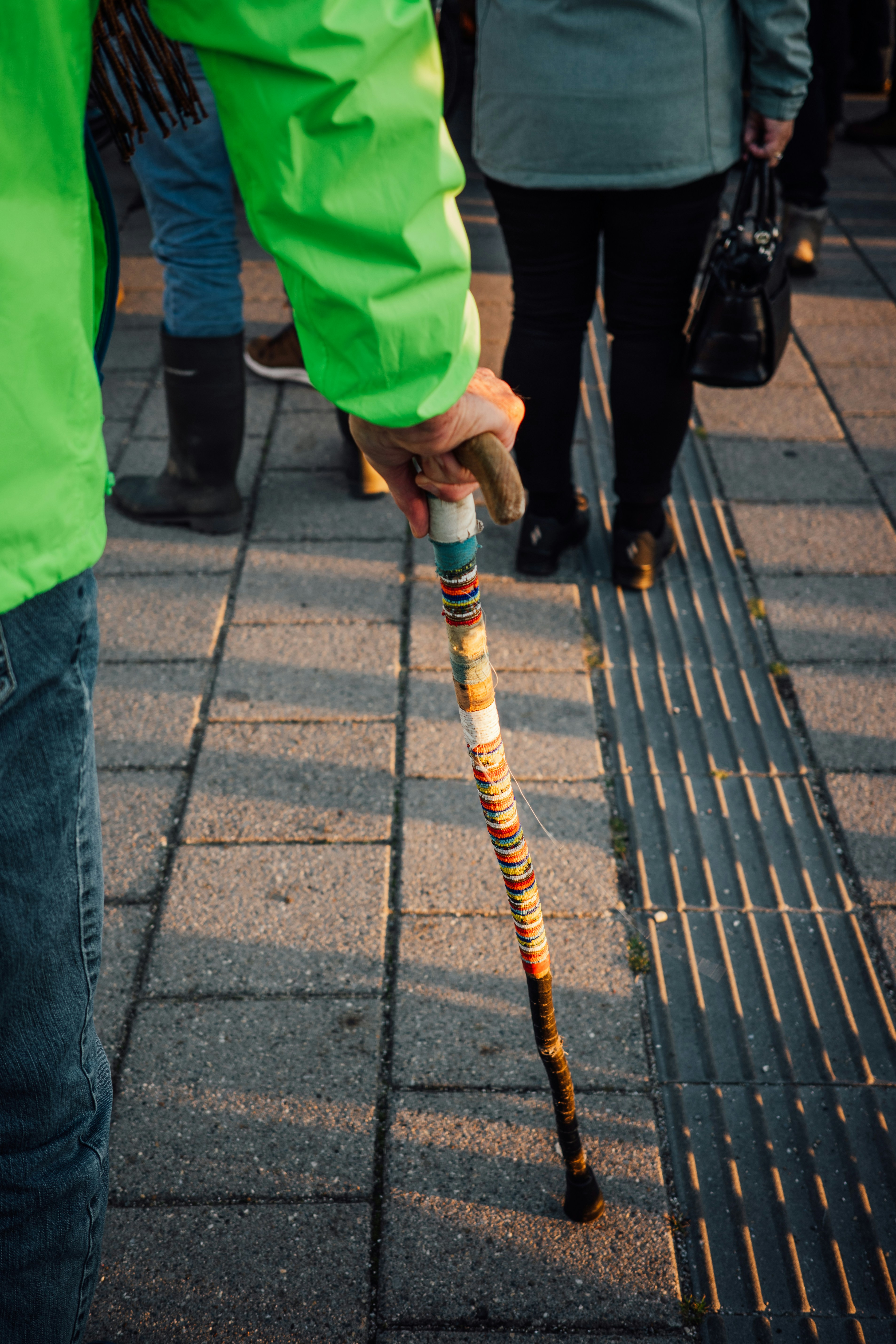 Beaded Walking Cane Tracing a Quiet Rhythm Along the City Sidewalk