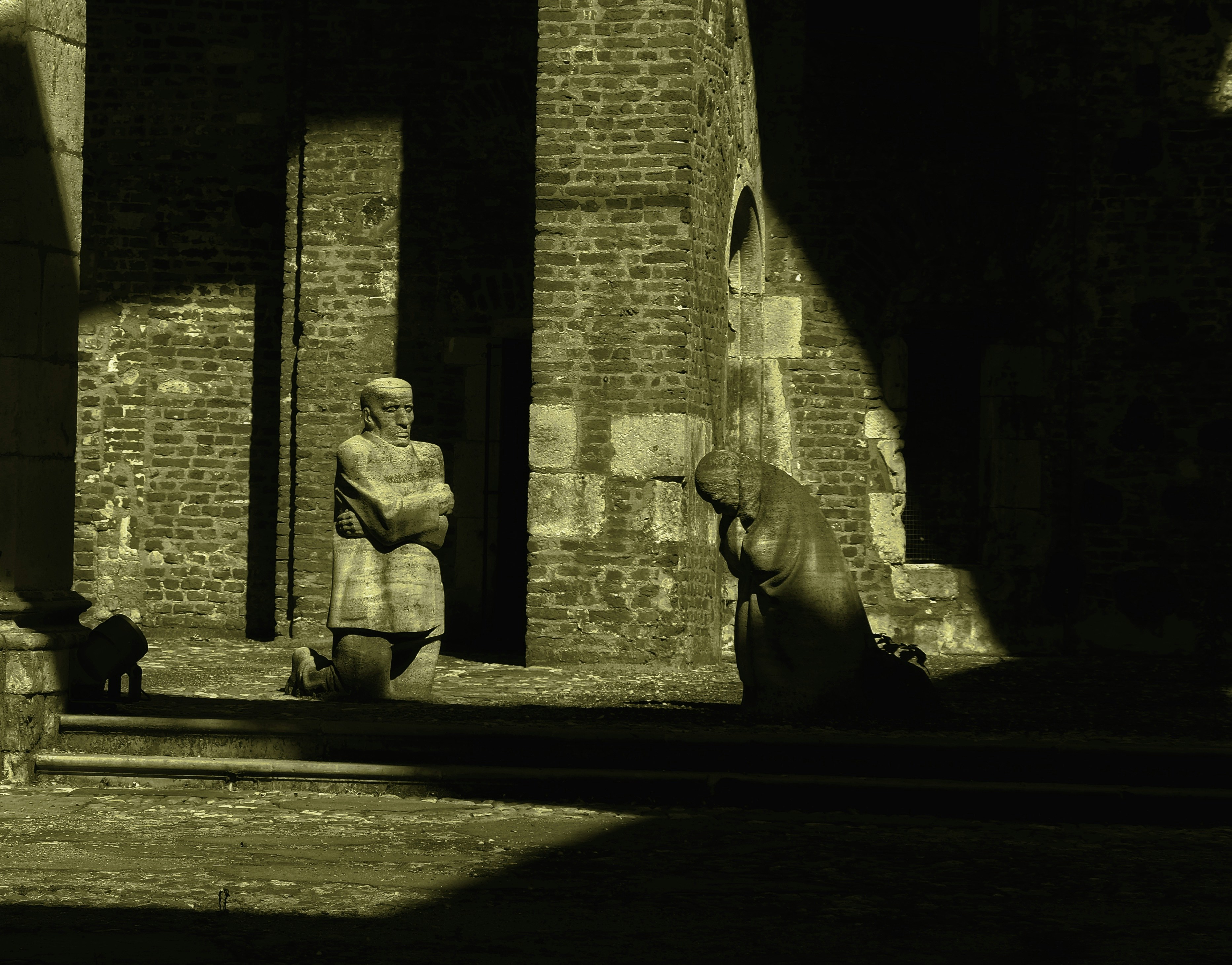 Stone Guardians in Sepia Shade Under a Brick Arch