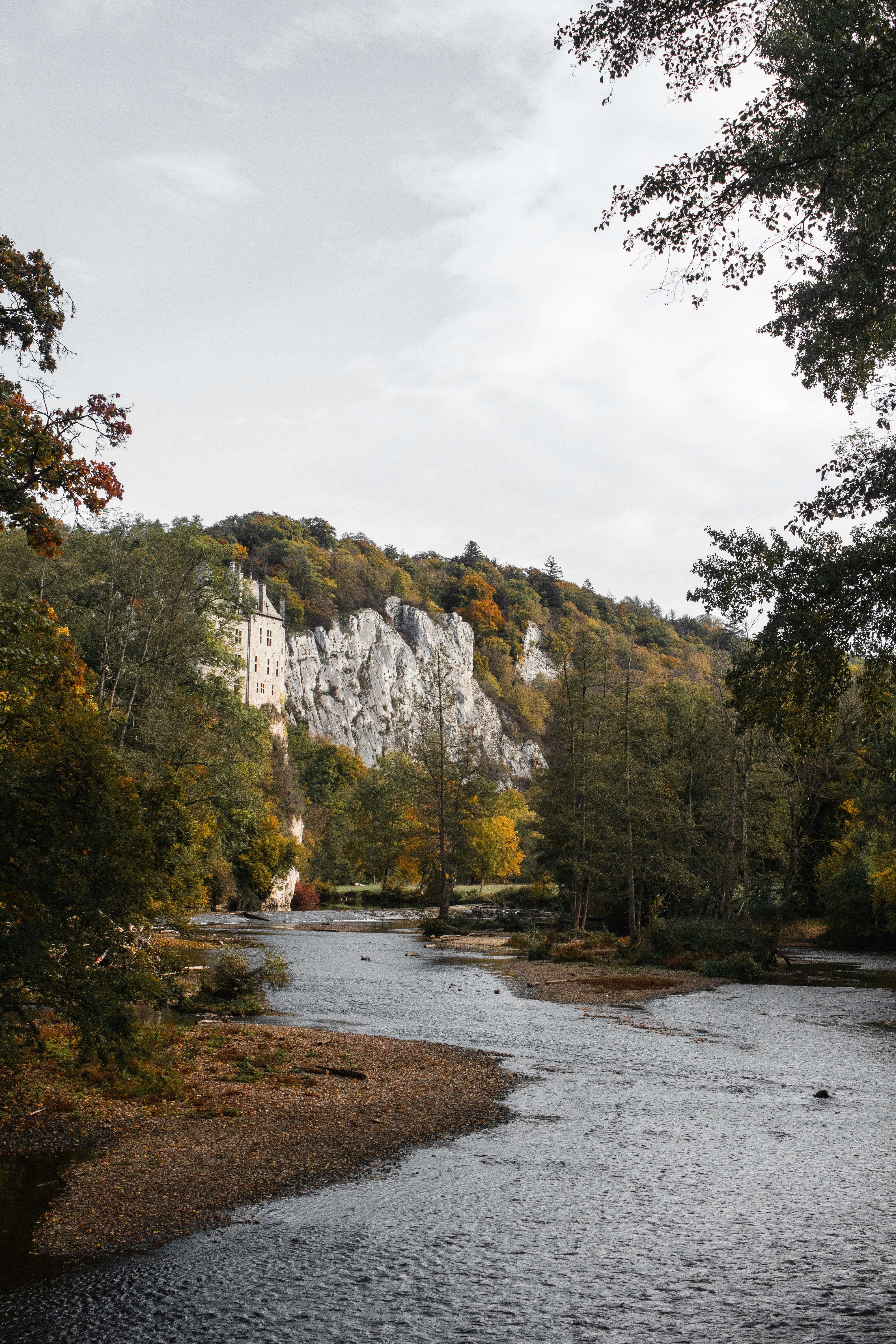 Cliffside Fortress in Autumn Light Over a Meandering River