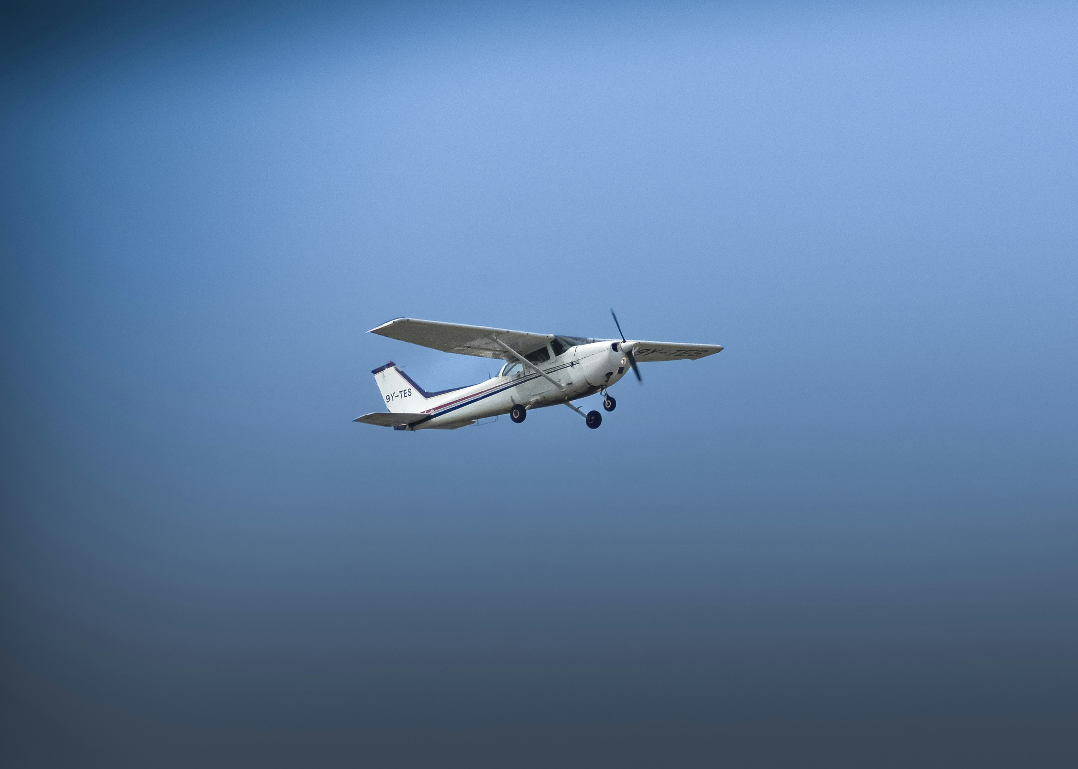 A small airplane flying in the sky photo – Free Piarco Image on Unsplash