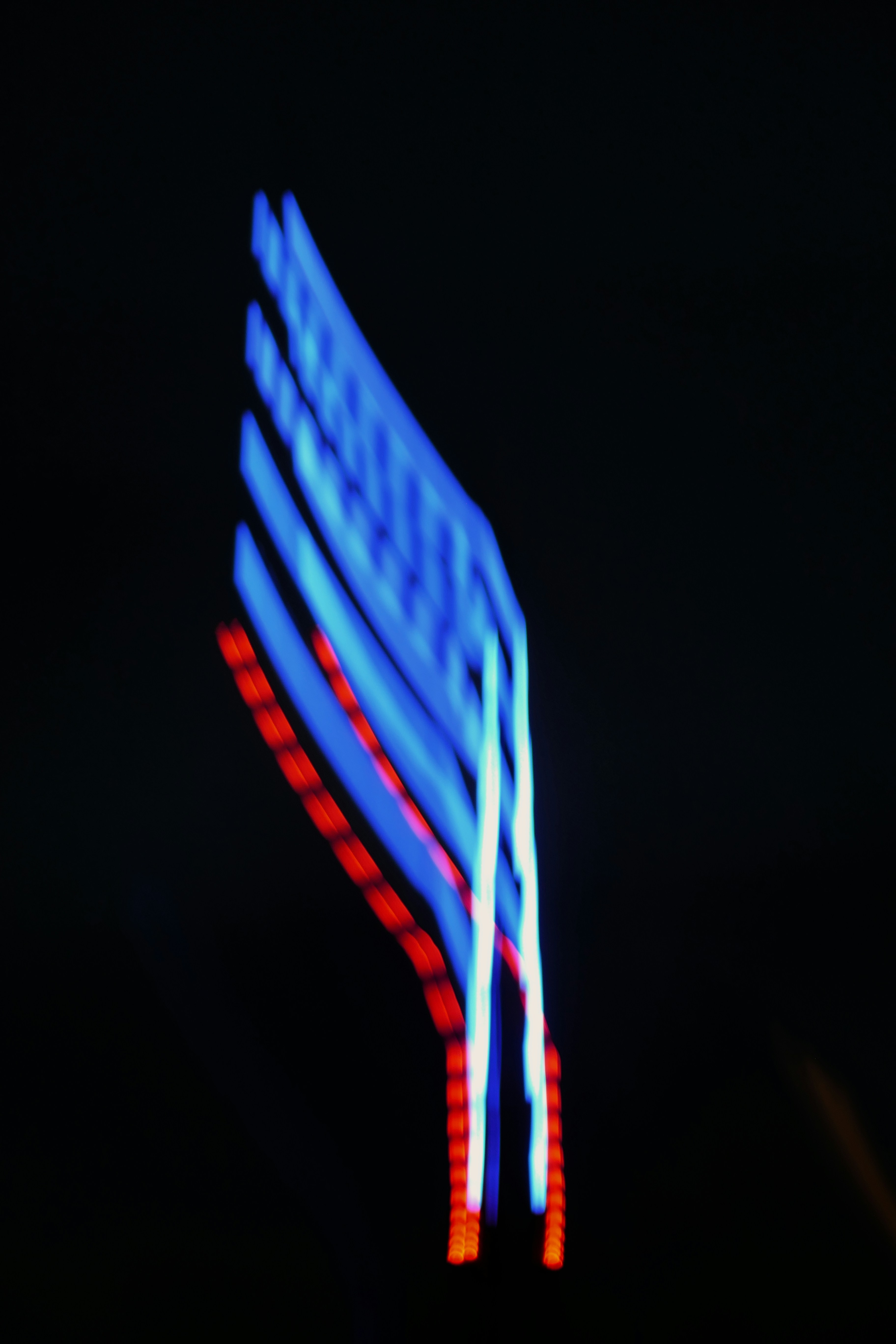 Neon Motion: Blue Sign Trails Against Night