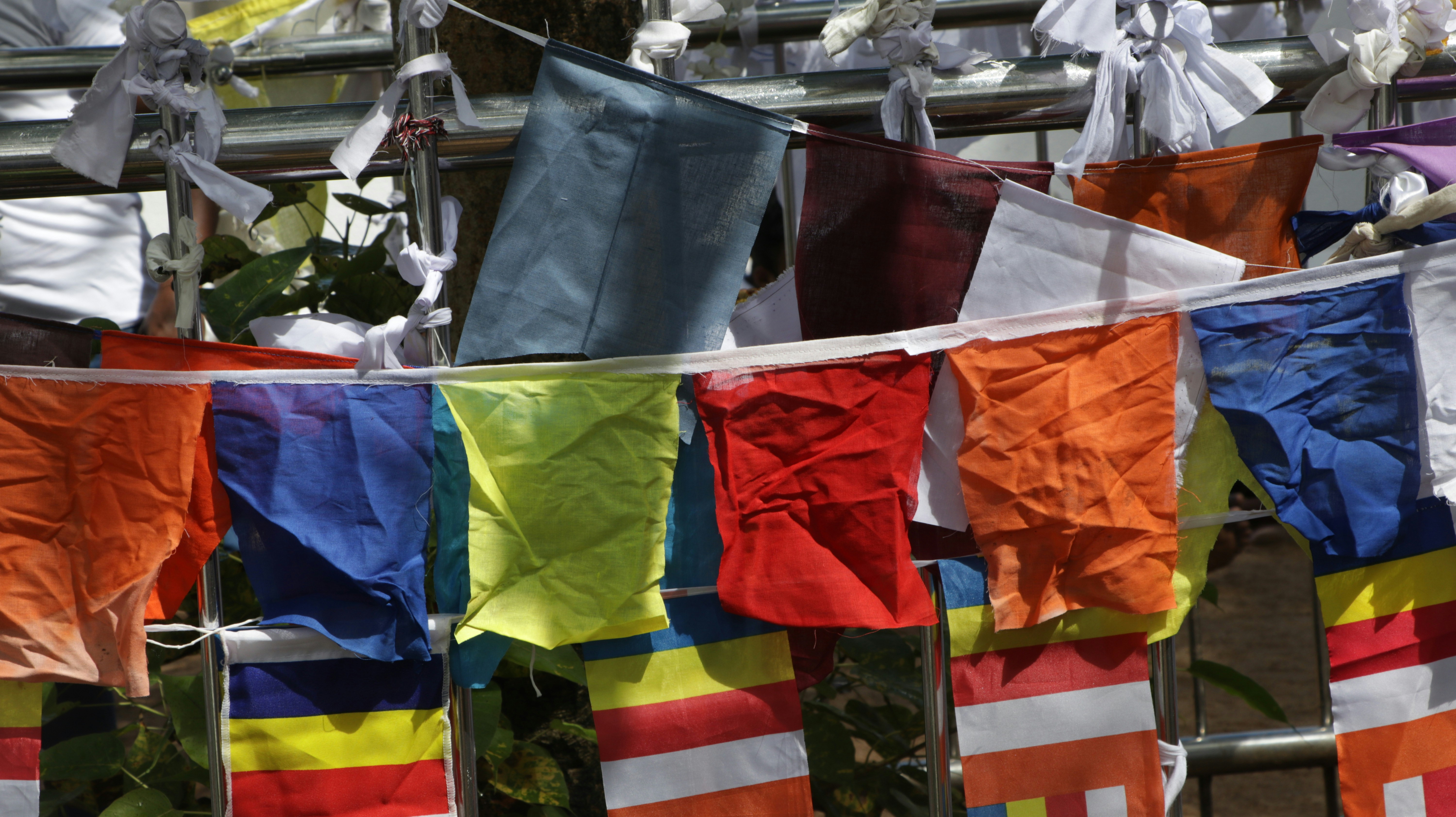 Kaleidoscope of Prayer Flags Draped Over Weathered Urban Railings