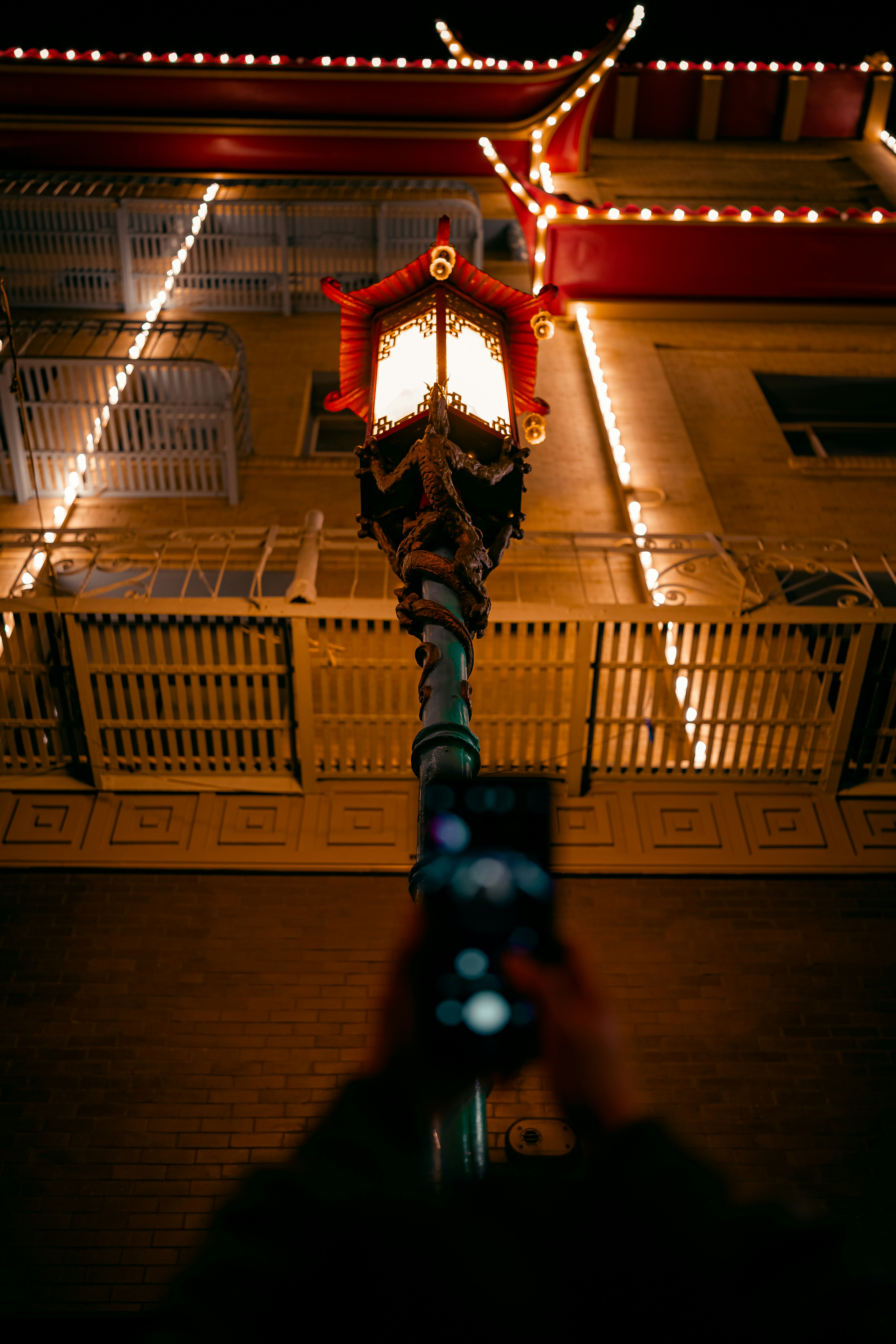 Lantern Above the Night Street: A Moment Captured in Neon and Glass