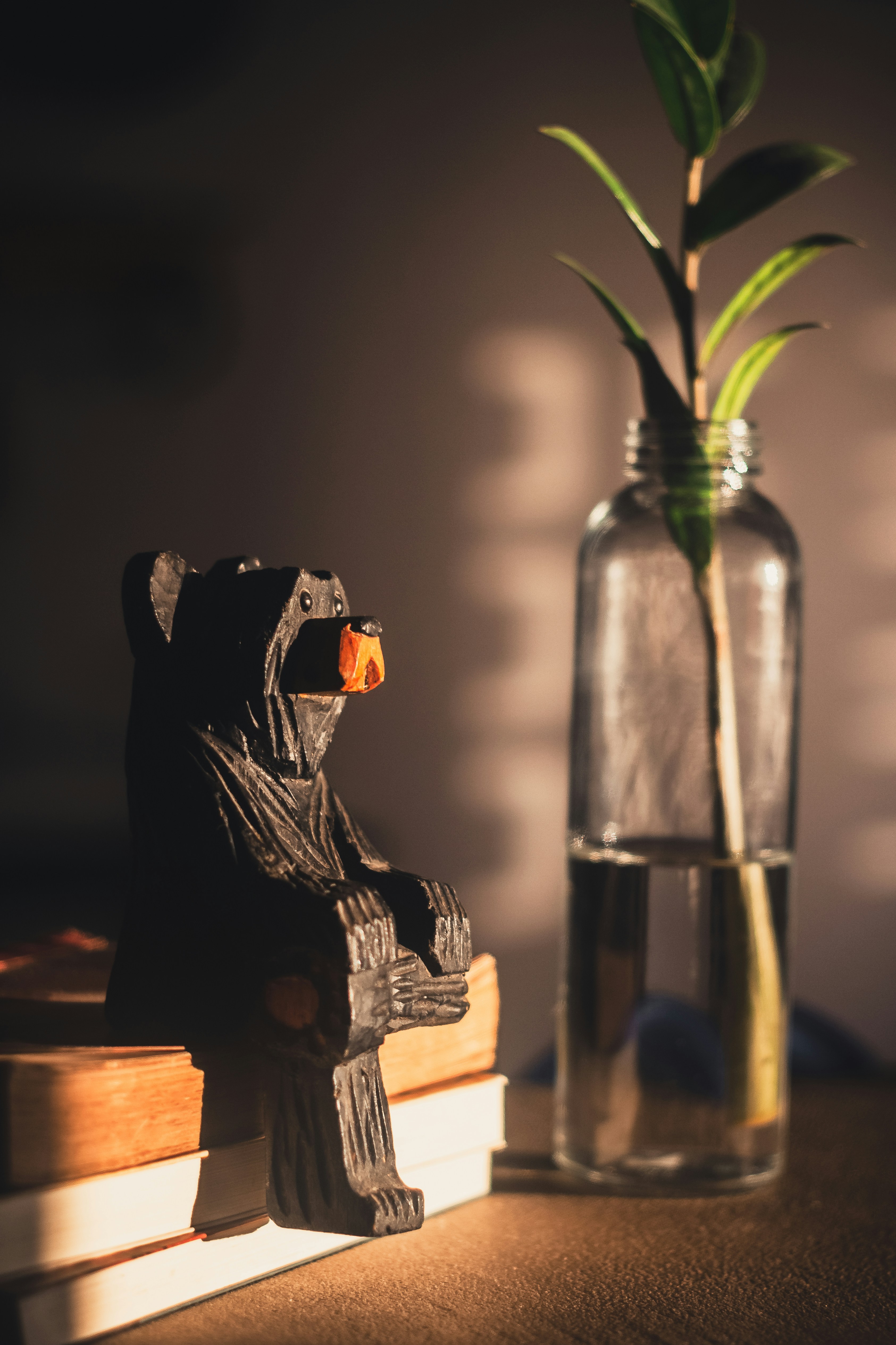 a glass vase with a statue of a tiger