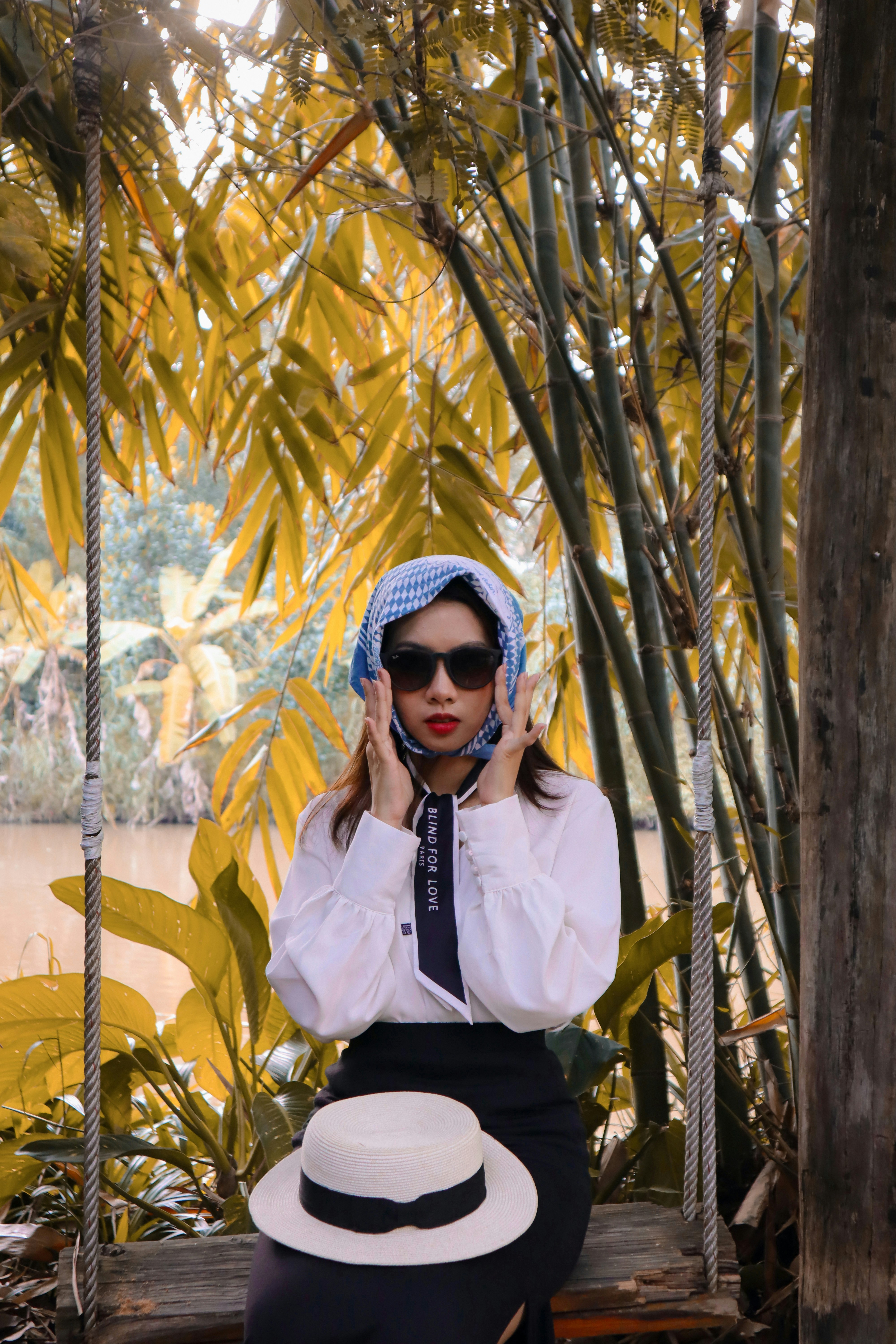 Sunlit Bamboo Swing Portrait: Quiet Glamour Among Golden Leaves