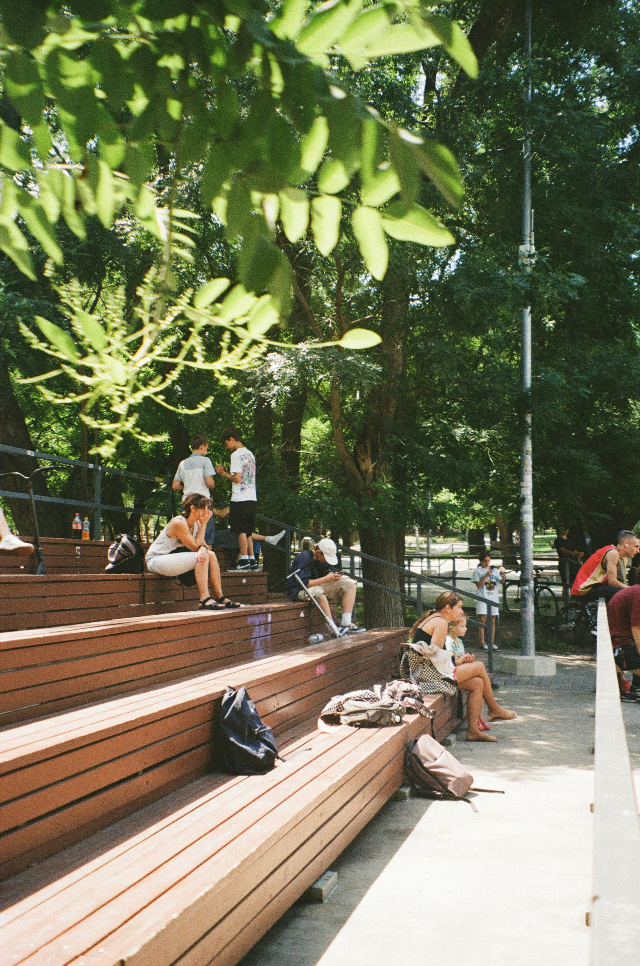A group of people sitting on benches photo – Free Park Image on Unsplash