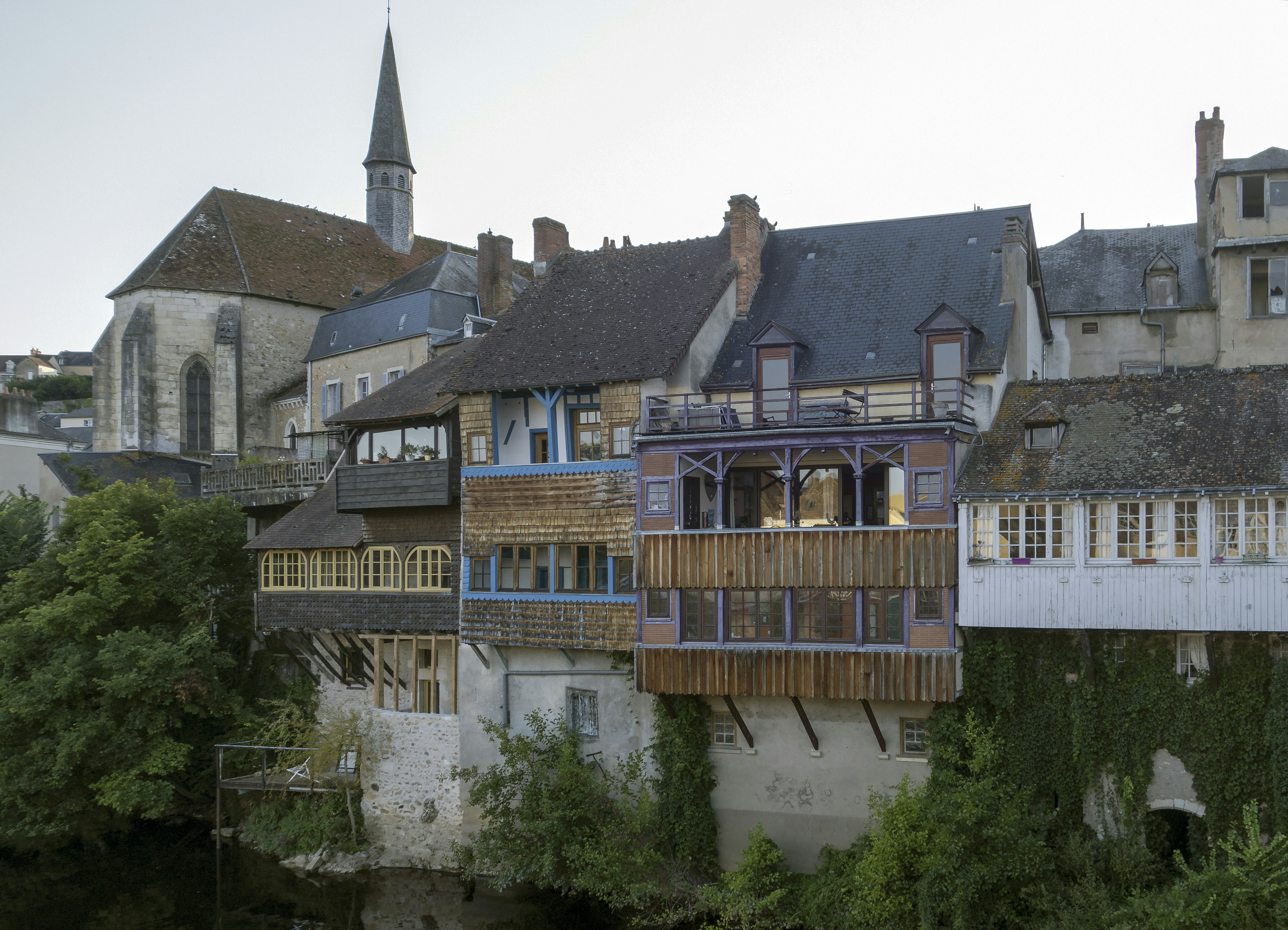 Riverside Rows: Timbered Facades Over Ivy and Stone