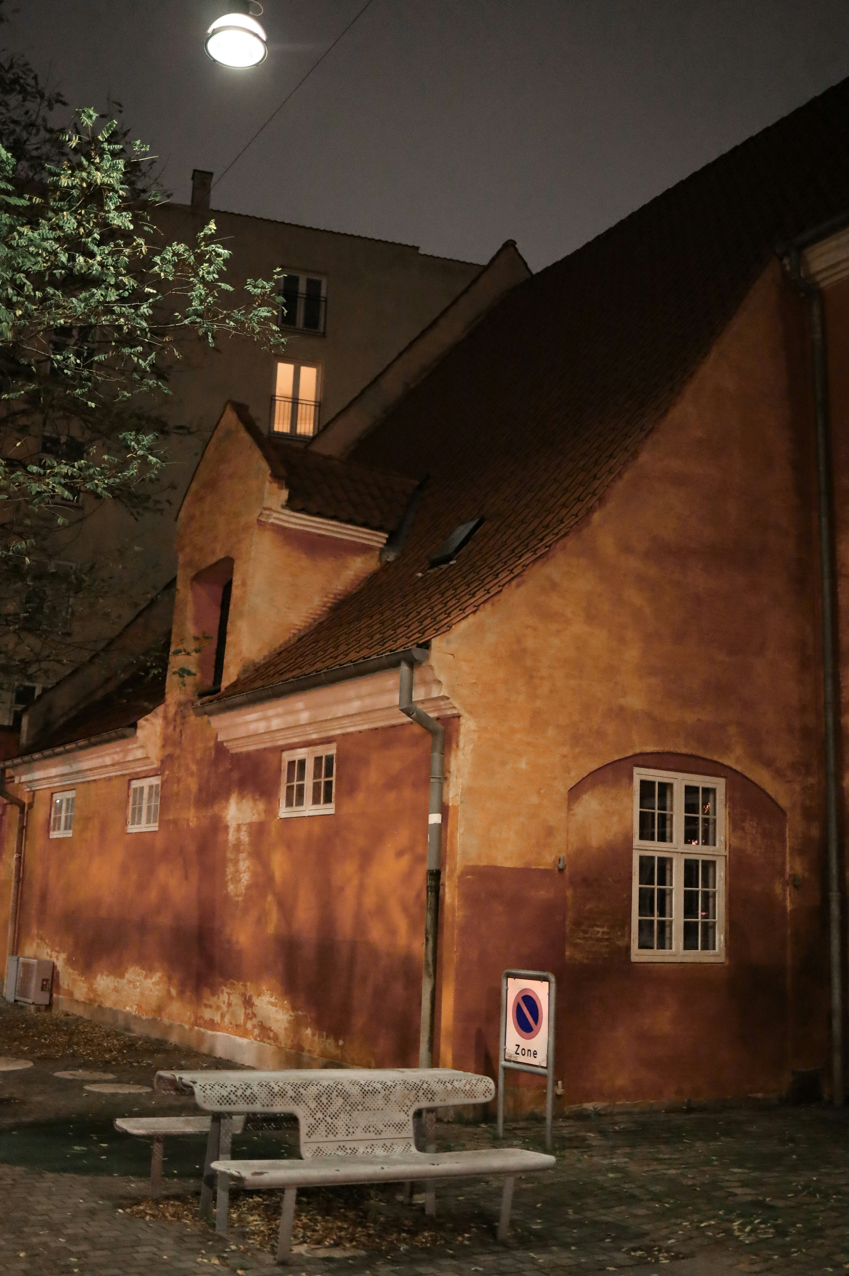 Moonlit Buckingham Alley: Warm Facade Under Night Sky