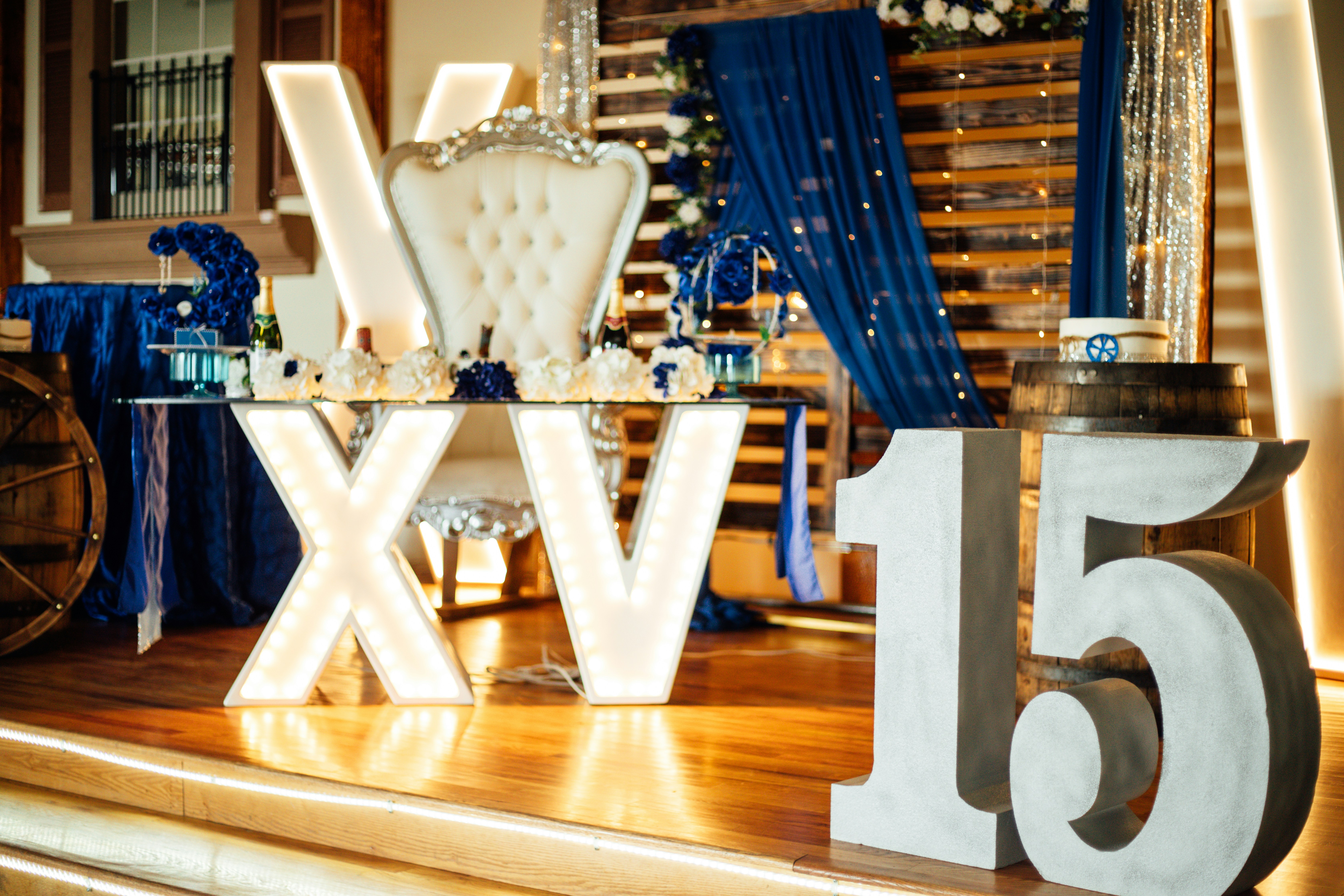 Majestic XV Celebration: Illuminated Letters and Throne on a Glowing Stage