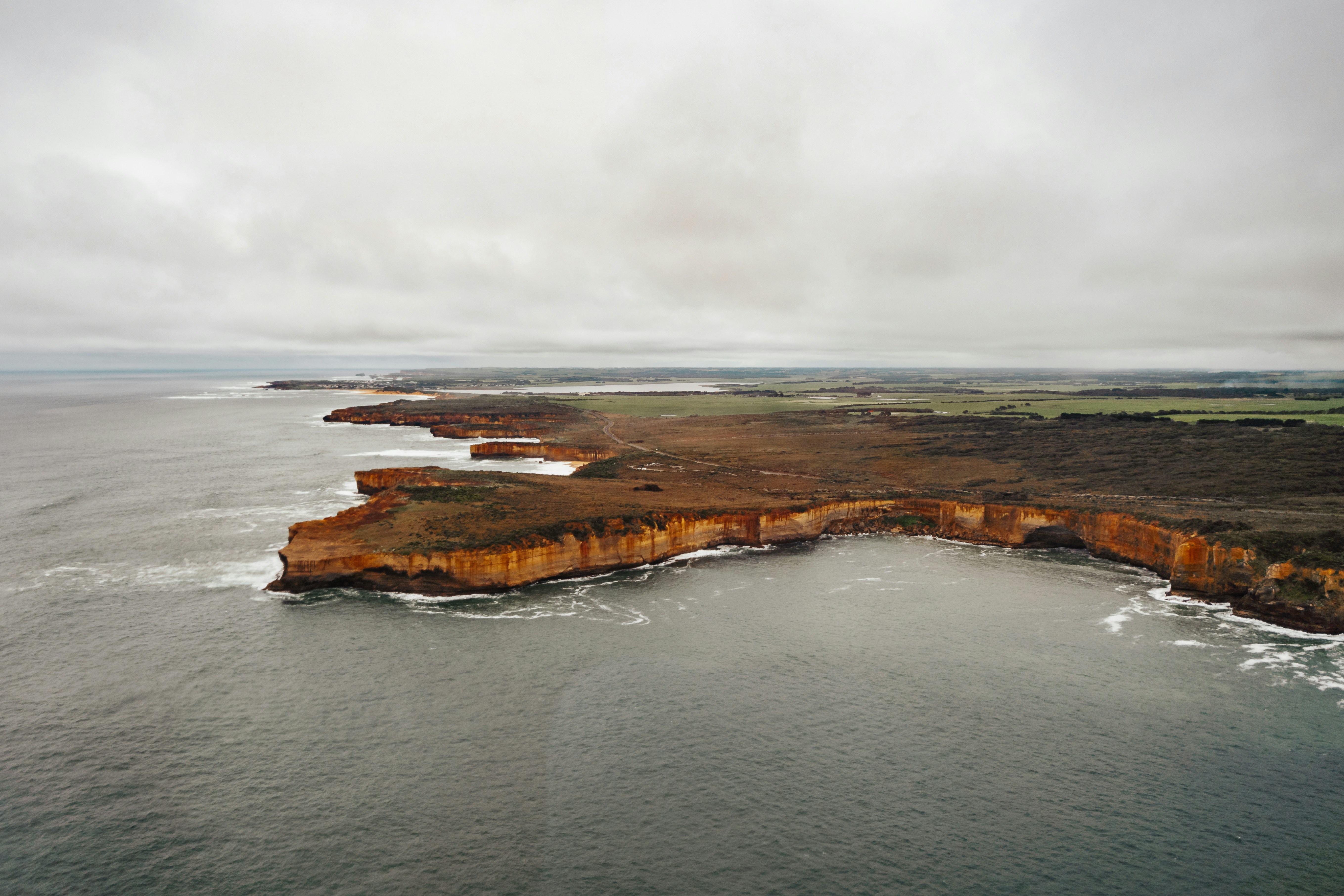 a large body of water with a large rock in the middle