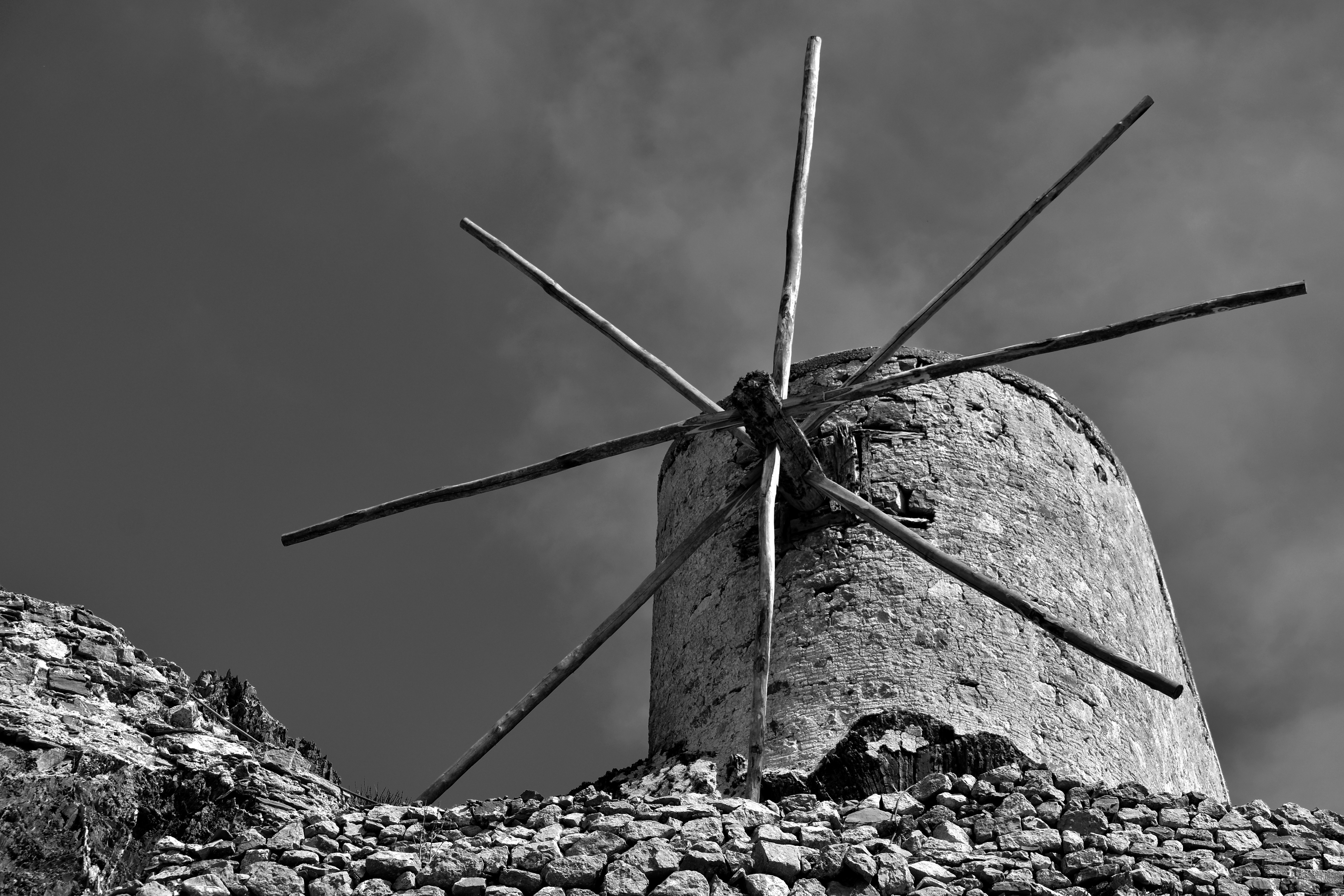 Radial Spokes Crown a Weathered Stone Turret Beneath a Cloudy Sky