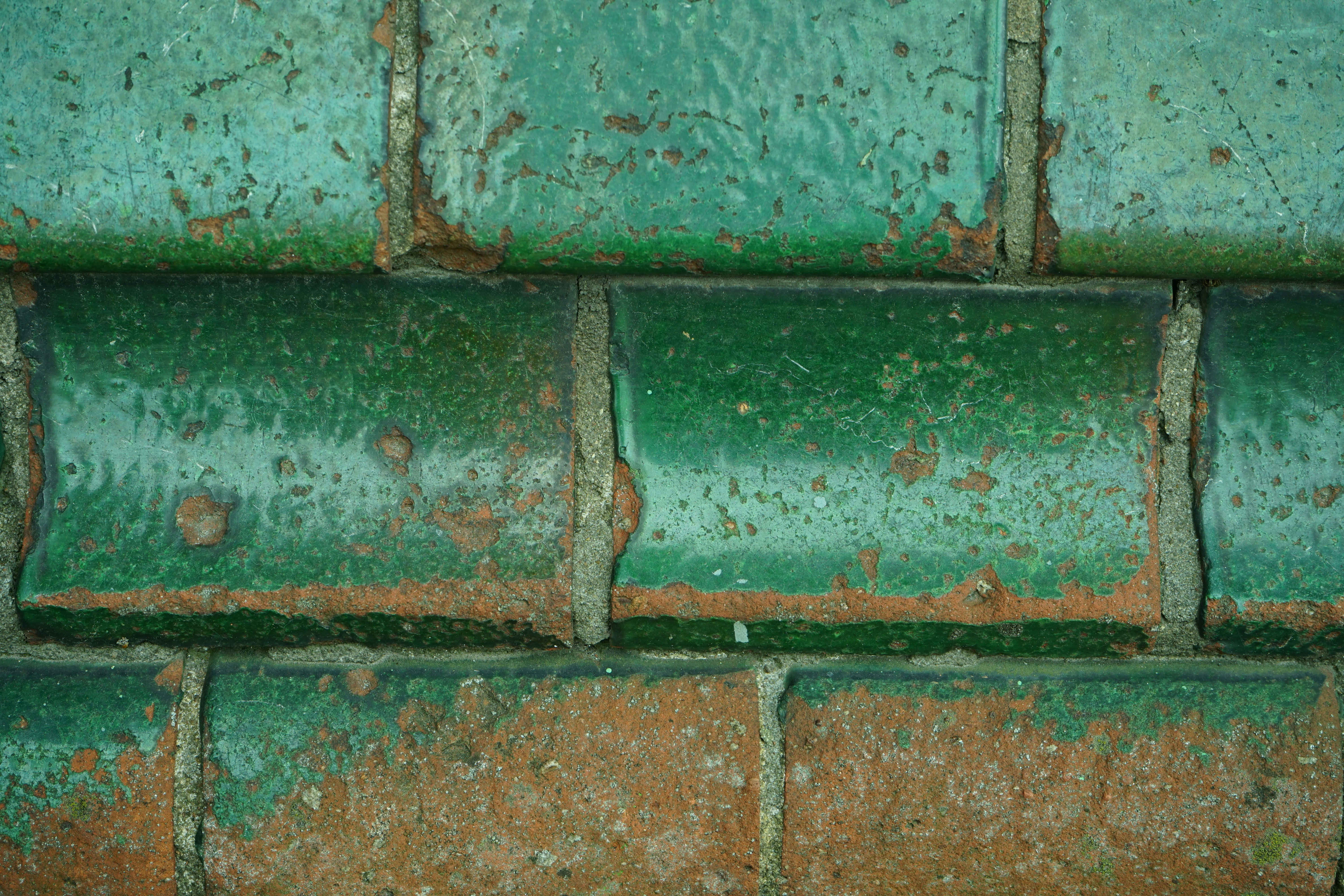 Patinated Green Brickwork: Rust-Touched Edges on a Quiet Facade