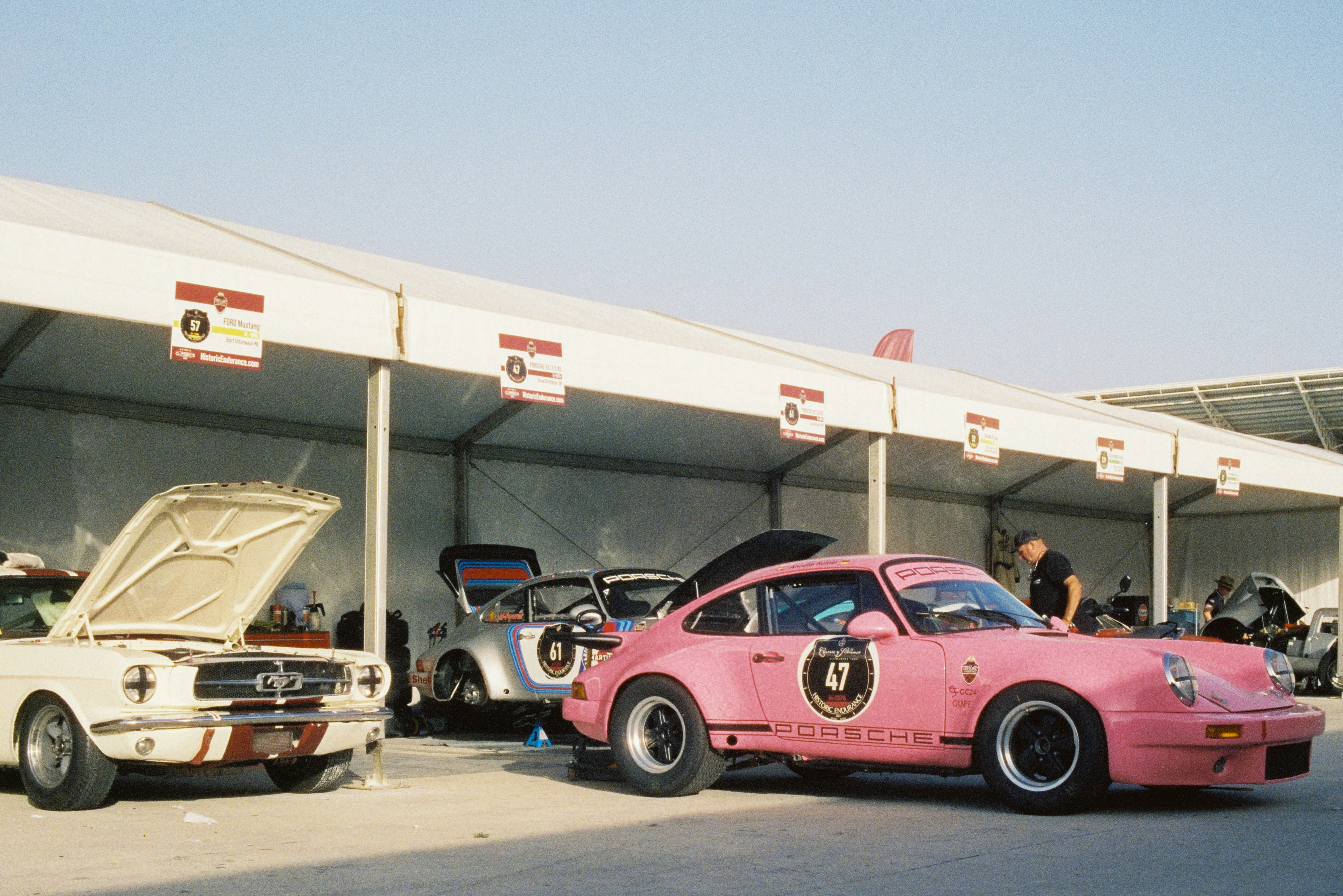 Sunlit Pink Porsche Plays Center in a Vintage Car Paddock