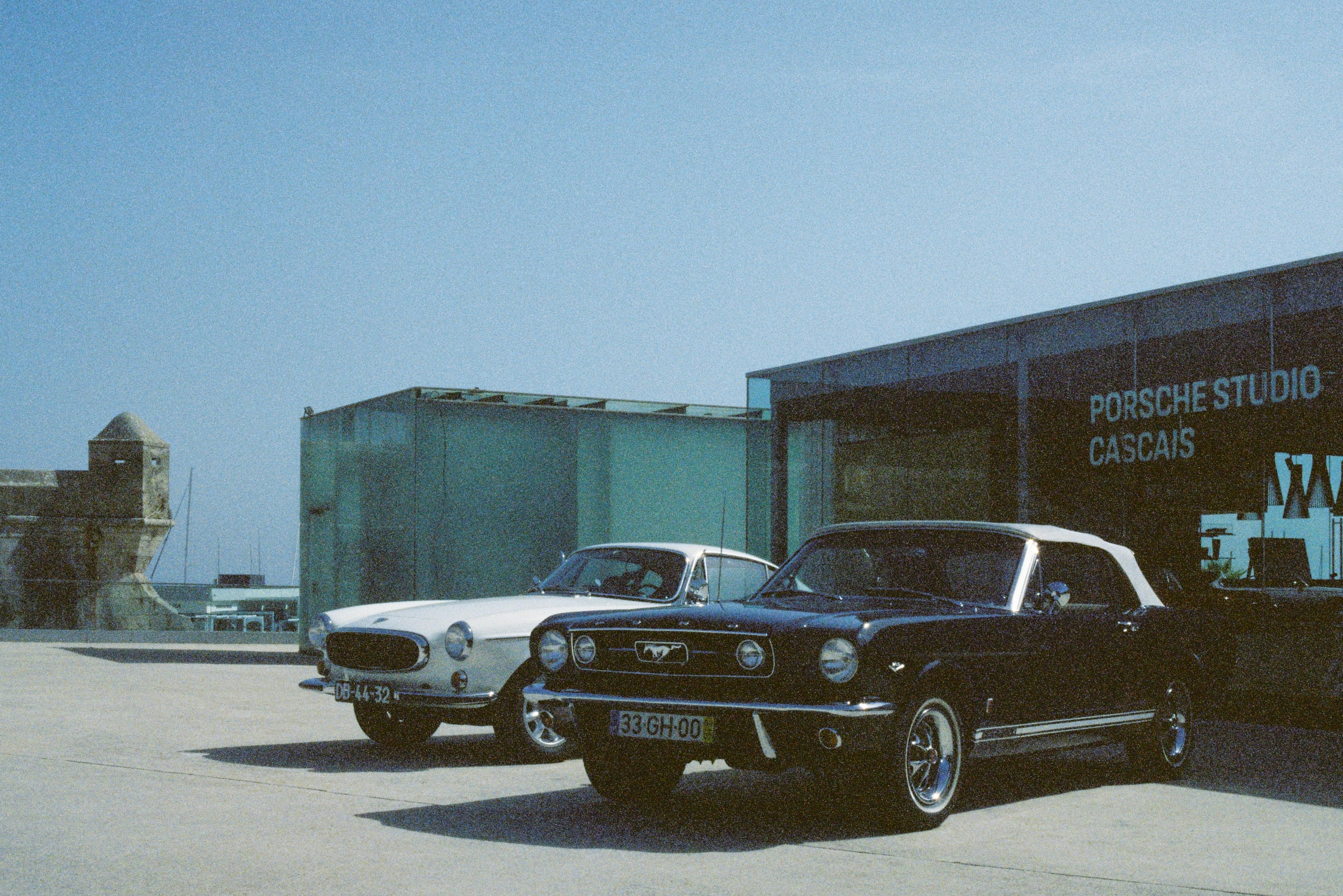Two Classic Alfa Beauties Parked by a Sunset-Tinted Studio