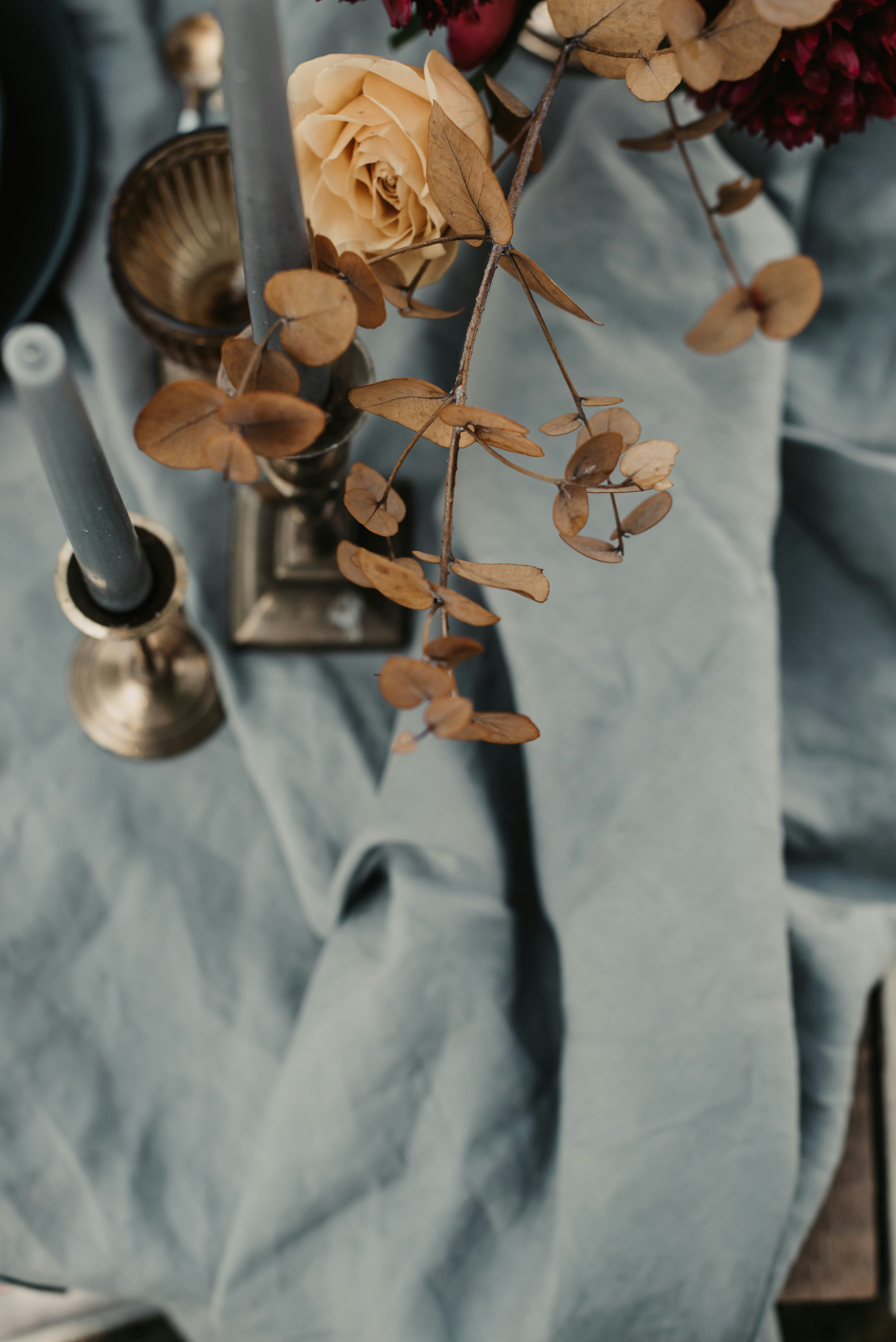 a vase with flowers and a spoon