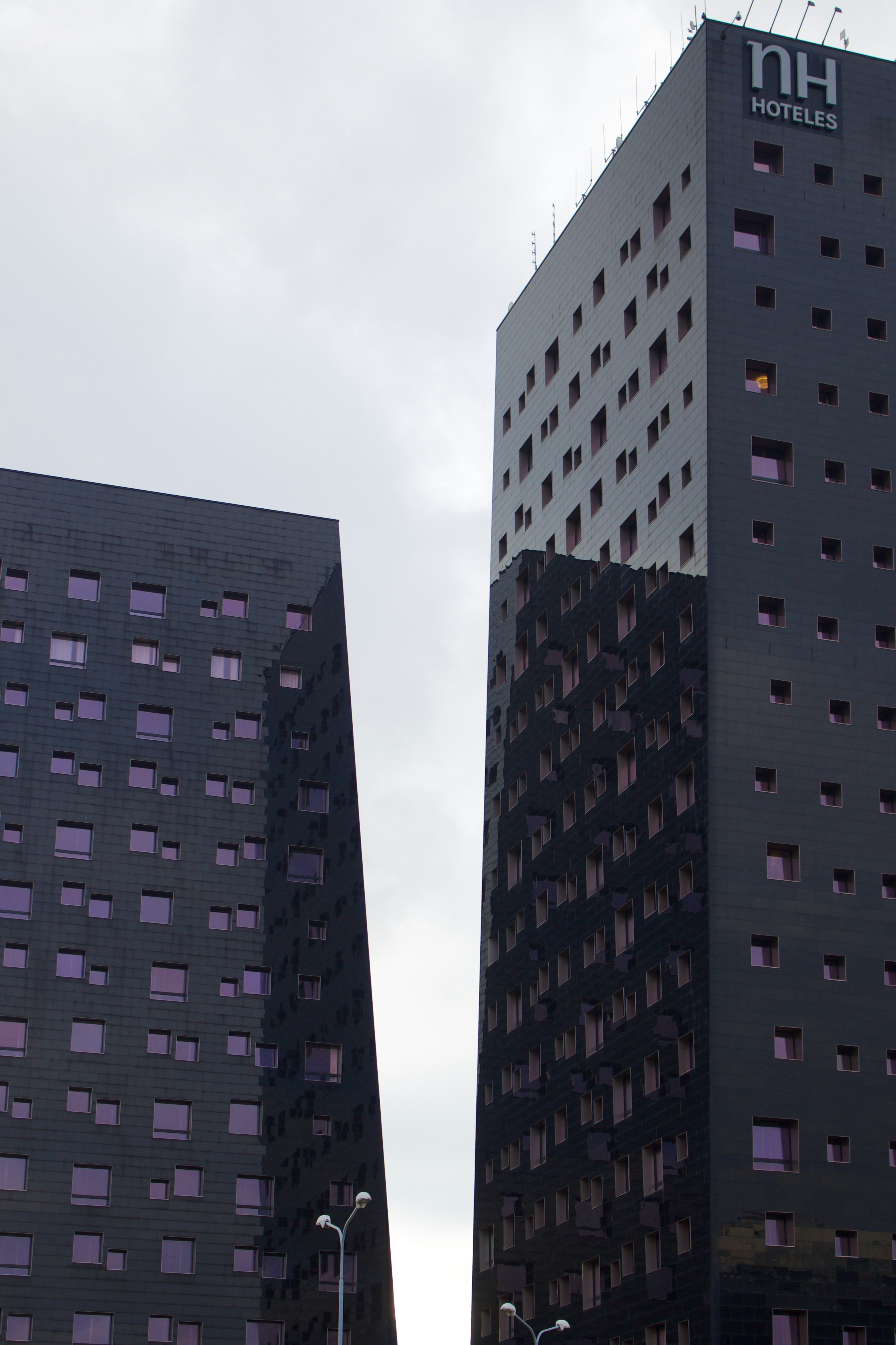 A couple of tall buildings photo – Free Hotel nh milano fiera Image on ...