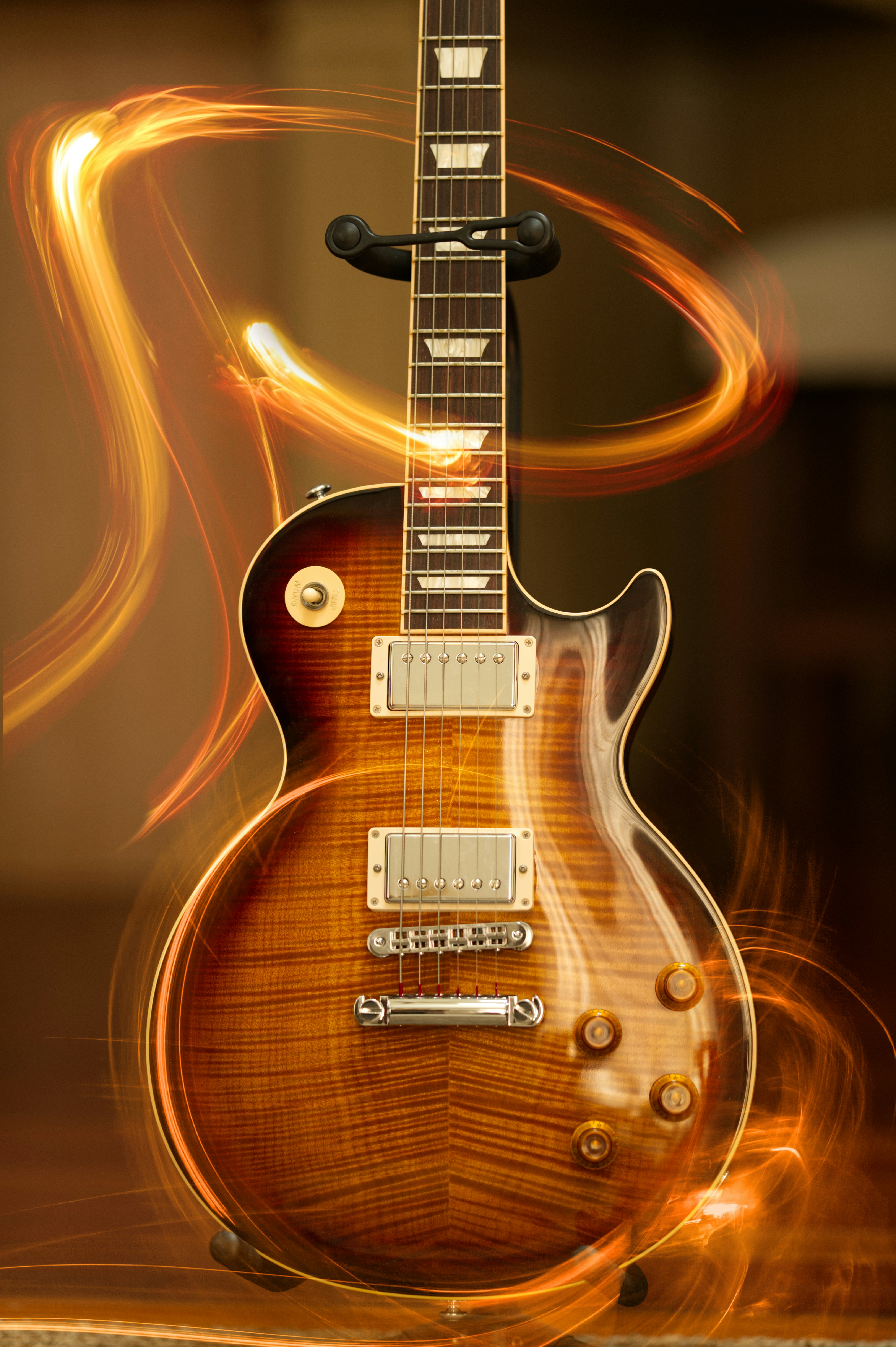 A beautifully crafted electric guitar illuminated by swirling light trails, emphasizing its elegant curves and rich wood grain.