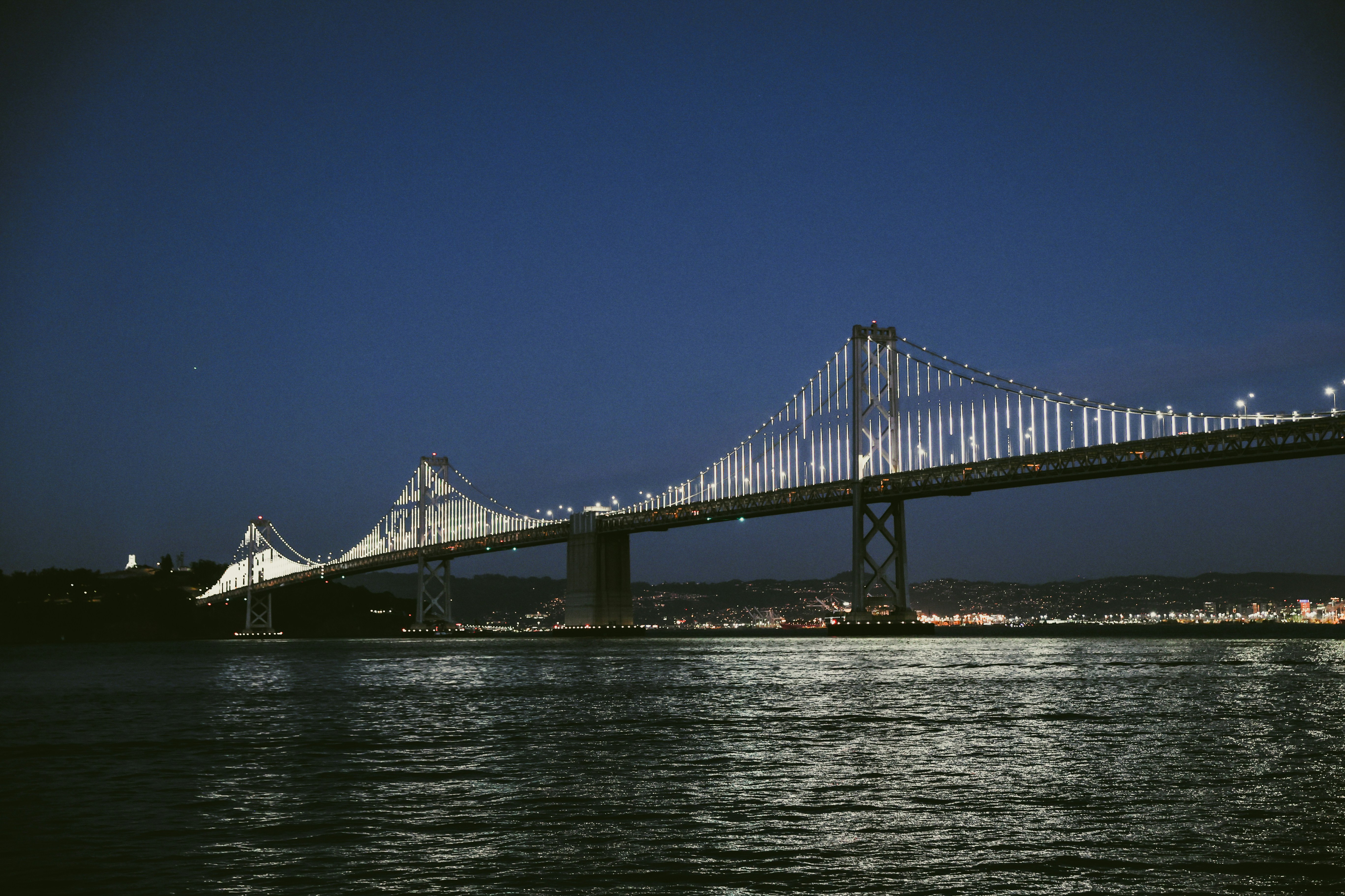 A bridge over water at night photo – Free Urban Image on Unsplash