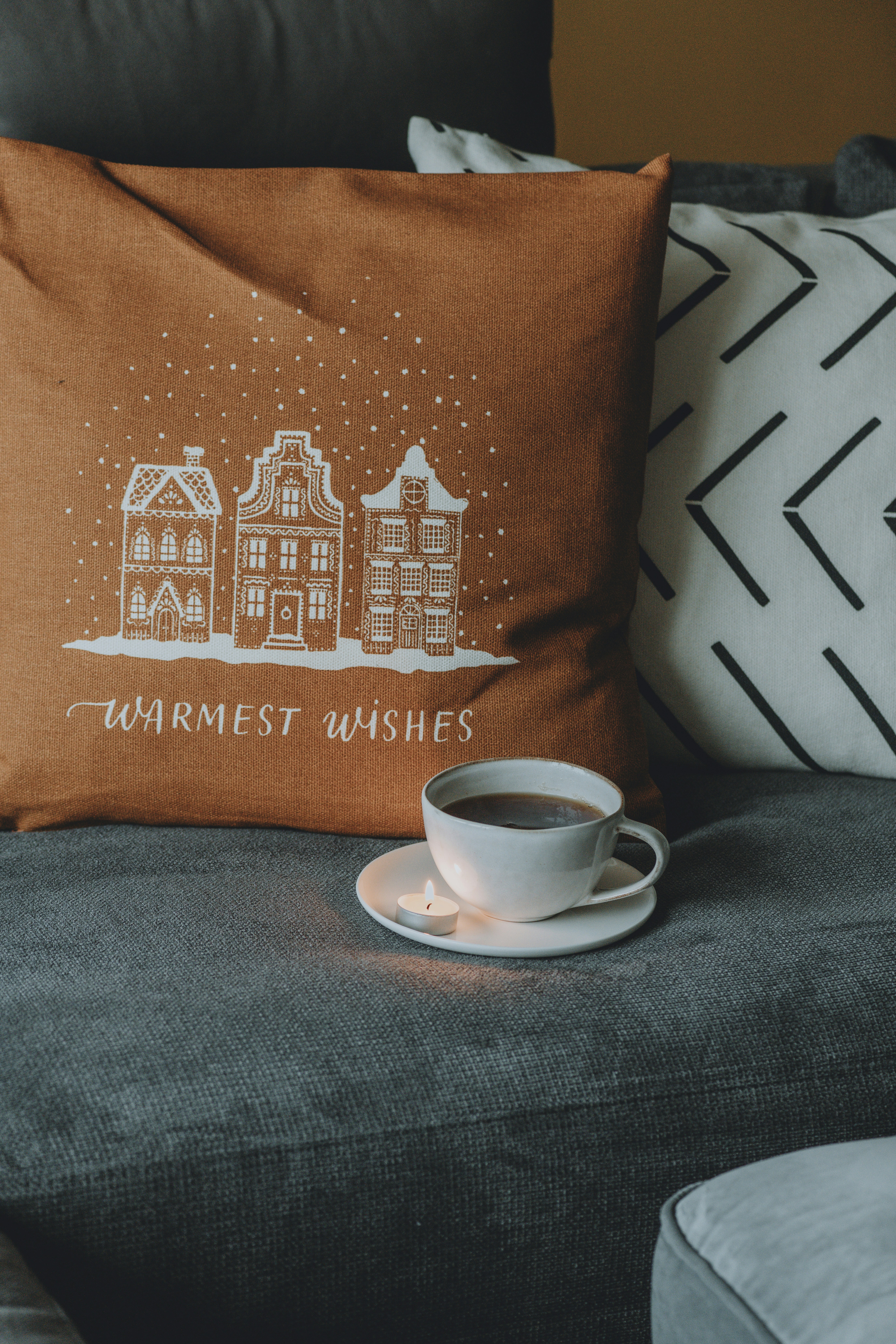 Warmth in Fabric: A Cozy Coffee Moment on a Sofa