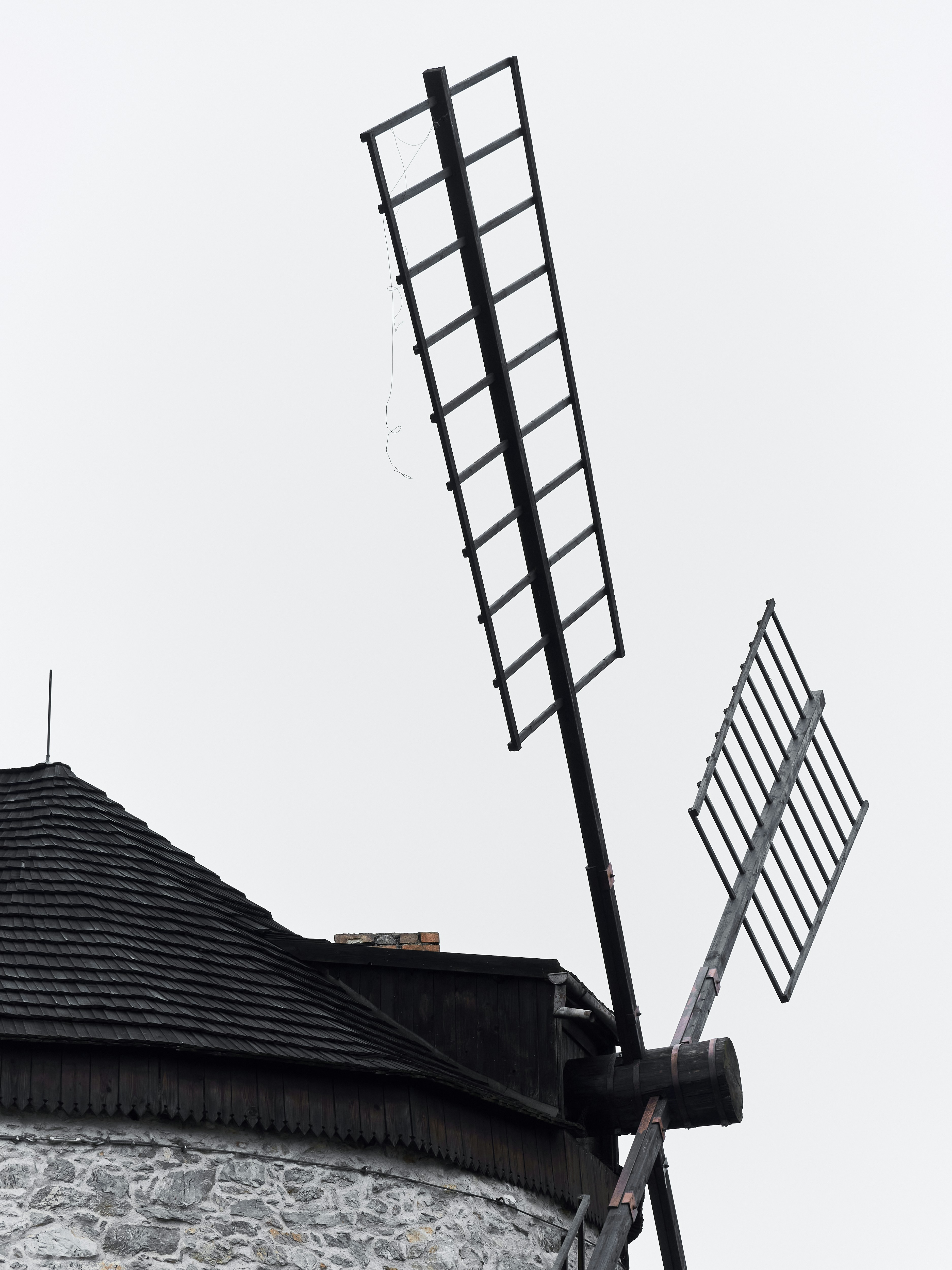 Grid Antennas Pierce a Pale Sky from a Weathered Rooftop